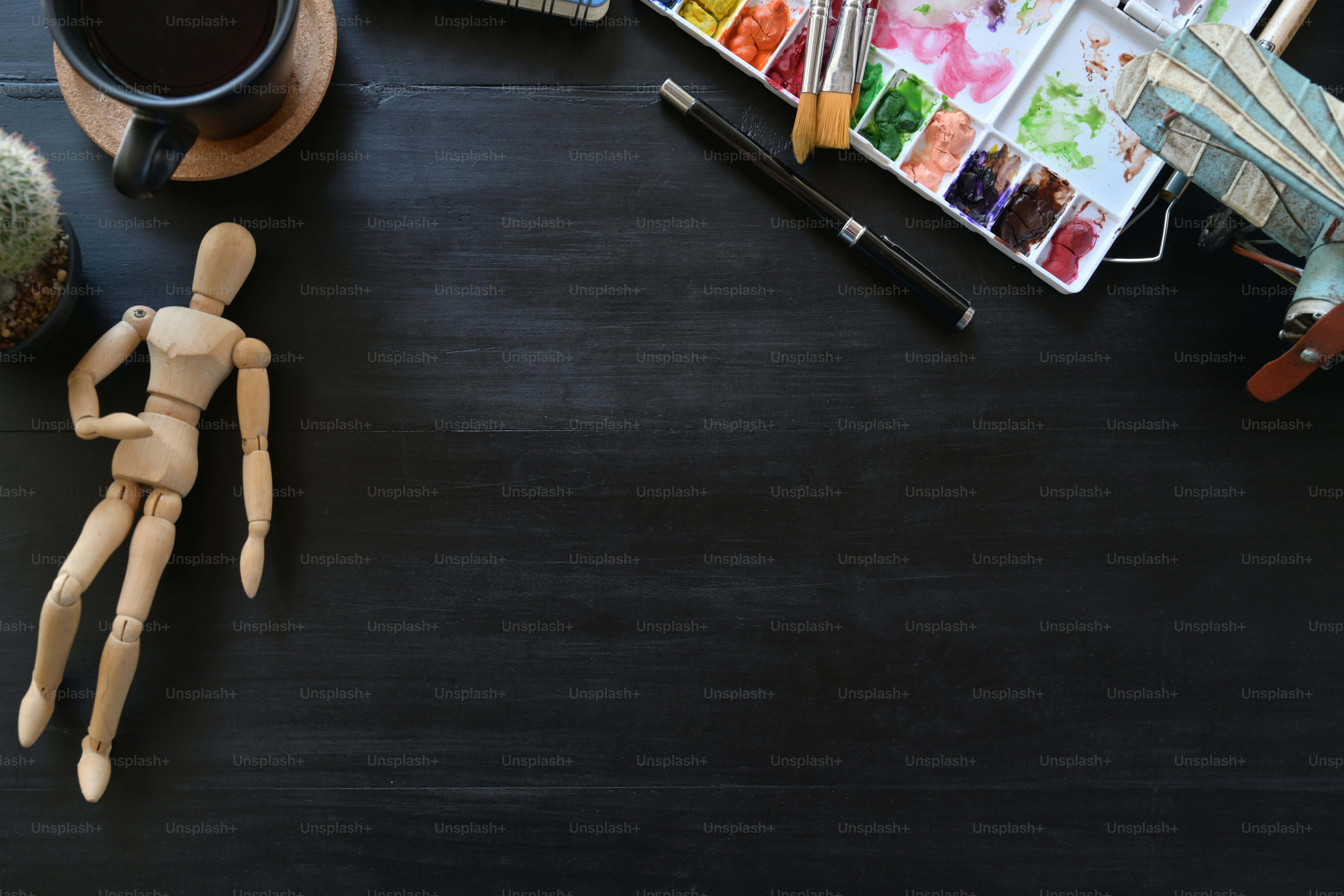 Artist workspace colour with creative accessories on dark wood table ...