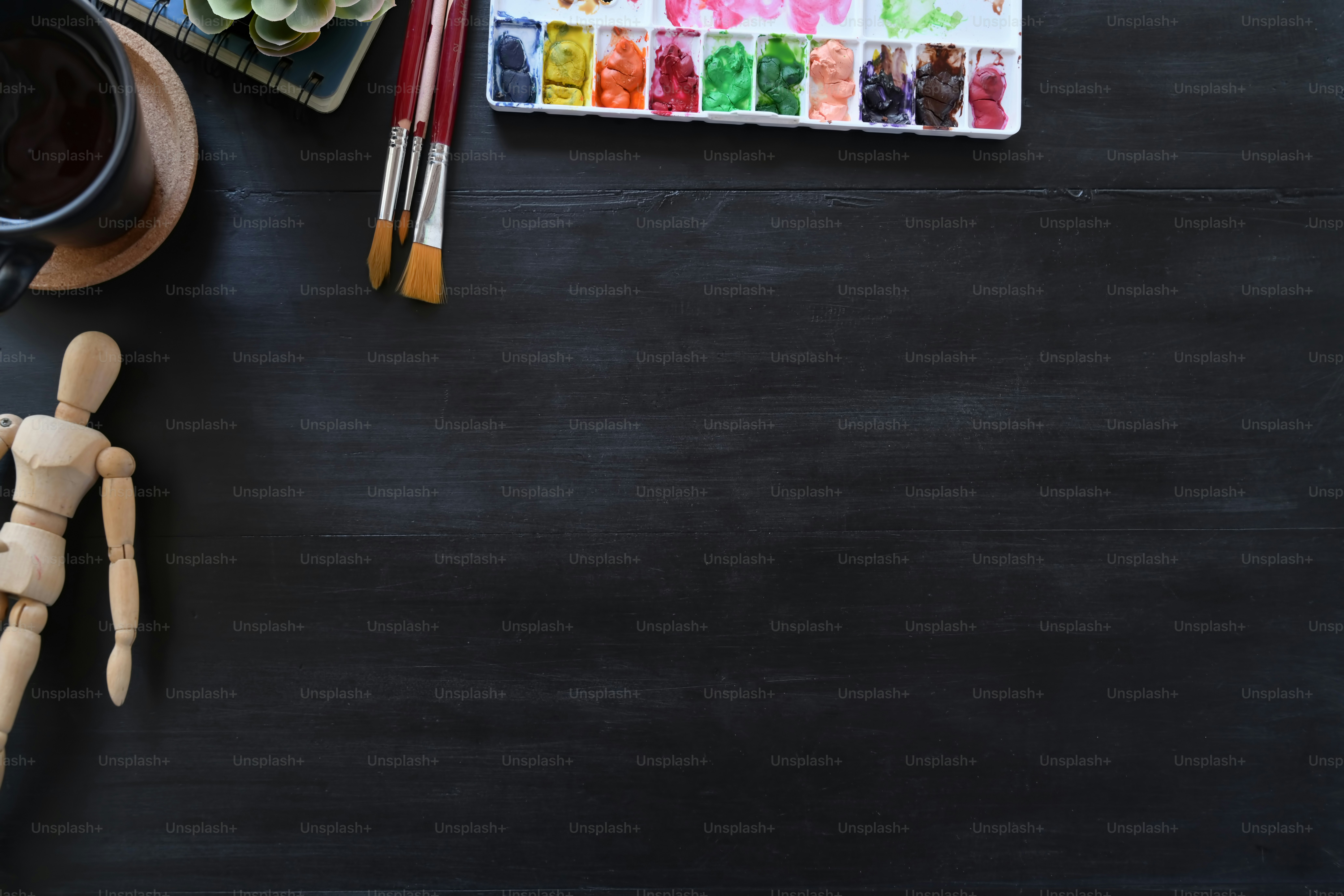 Artist workspace colour with creative accessories on dark wood table ...