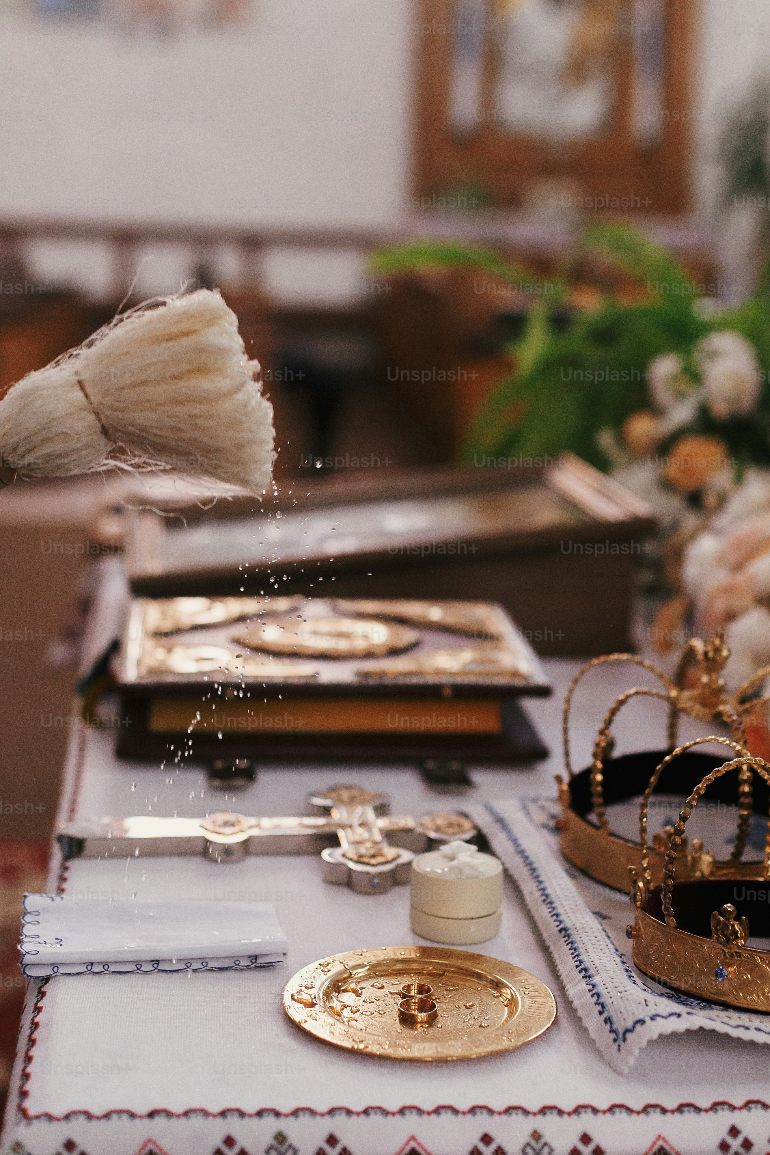 Priest blessing golden wedding rings on altar with holy water. Wedding ...