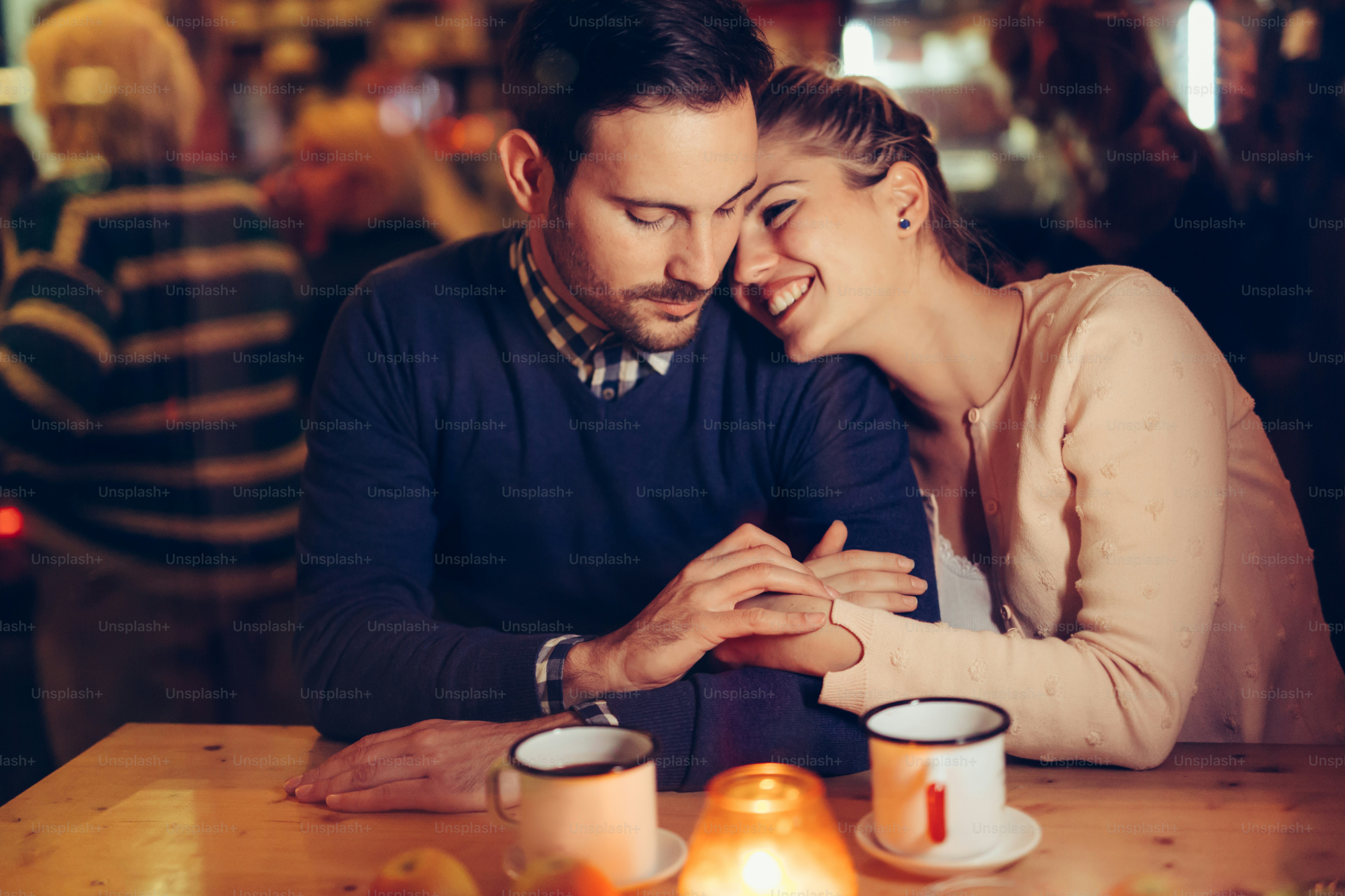 Romantic young couple dating in pub at night photo – Dating Image on ...