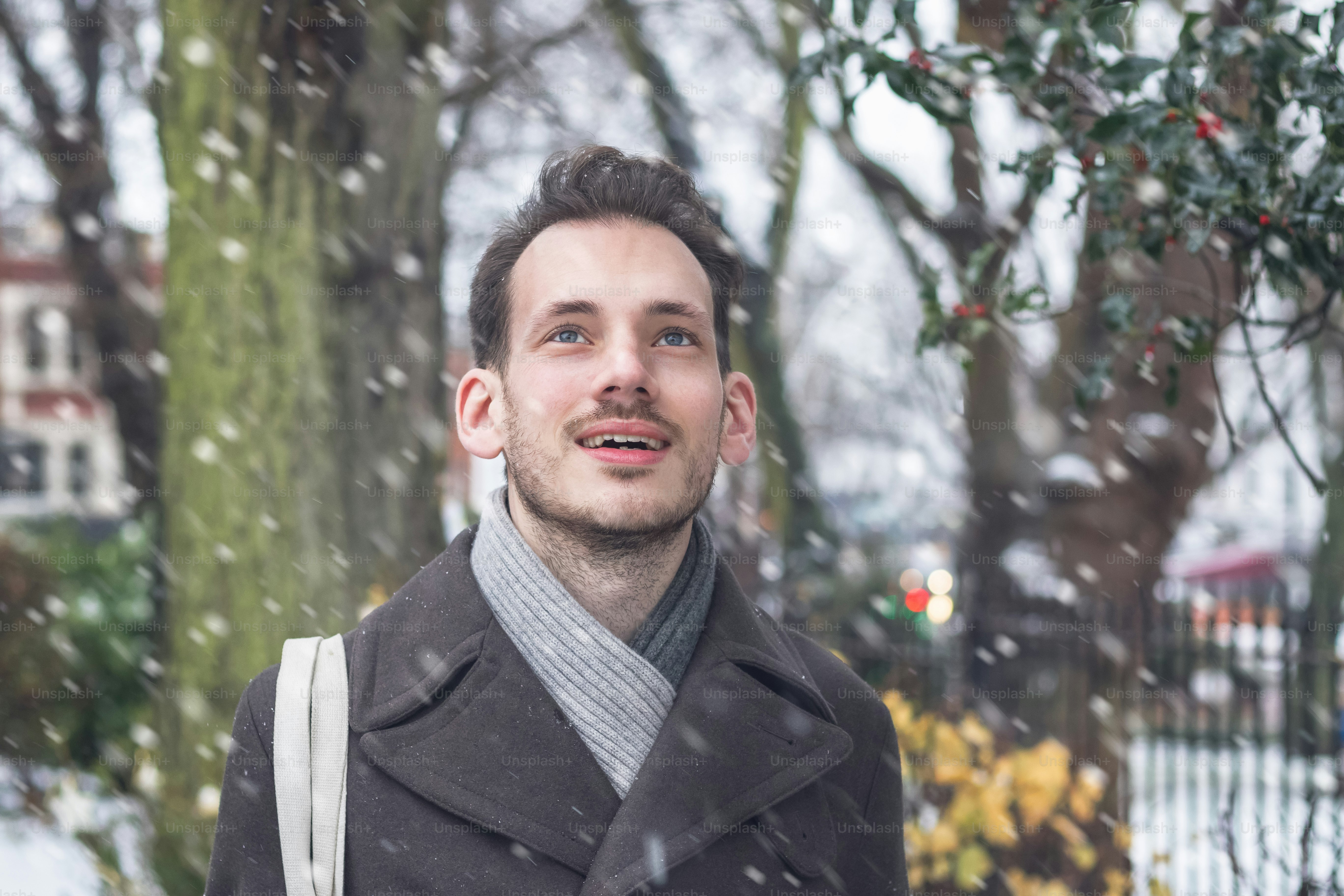 Portrait of a handsome young man in winter snow photo – Snow falling ...