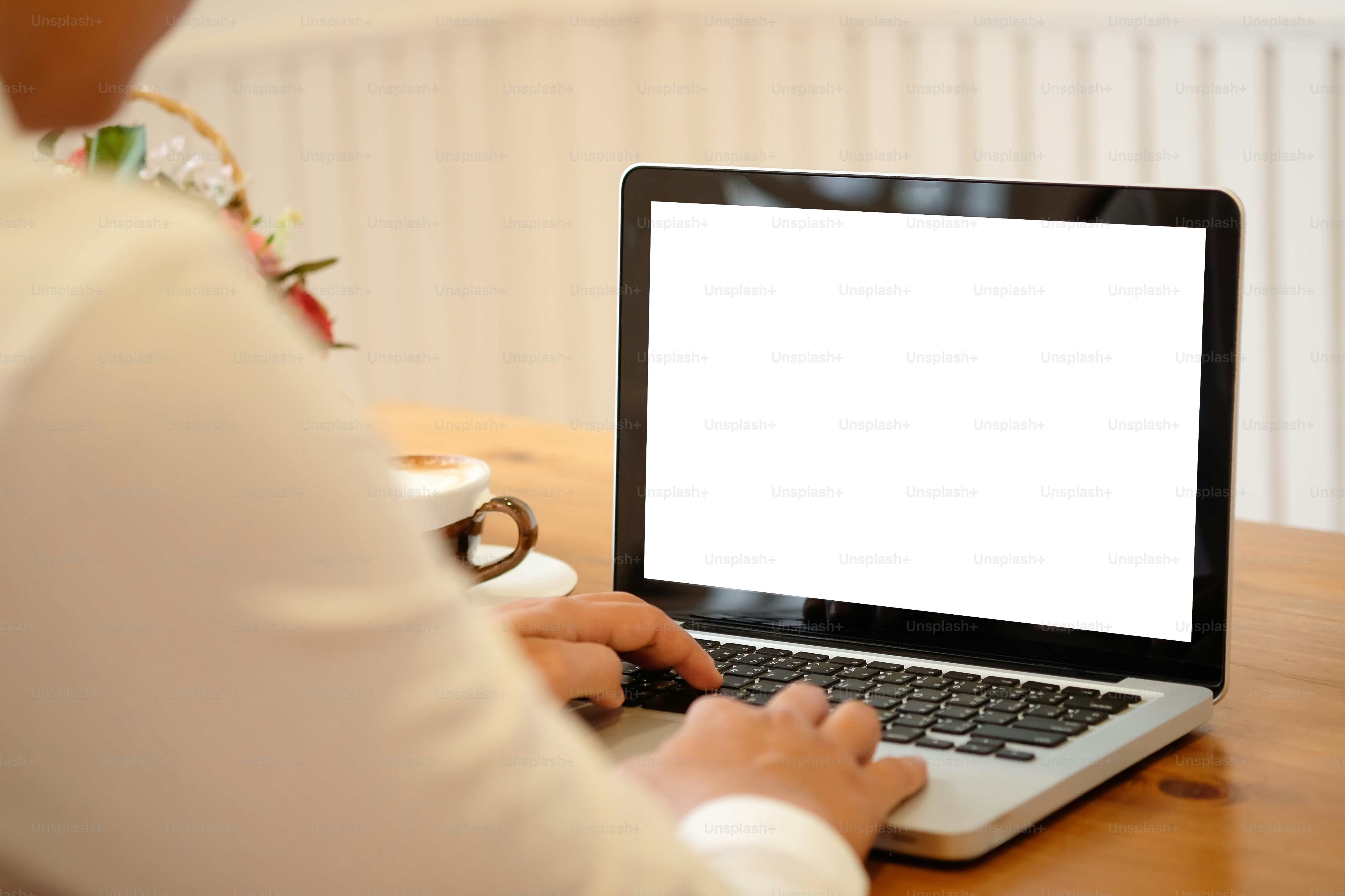 A Man using mockup laptop computer on wood table. photo – Office Image ...