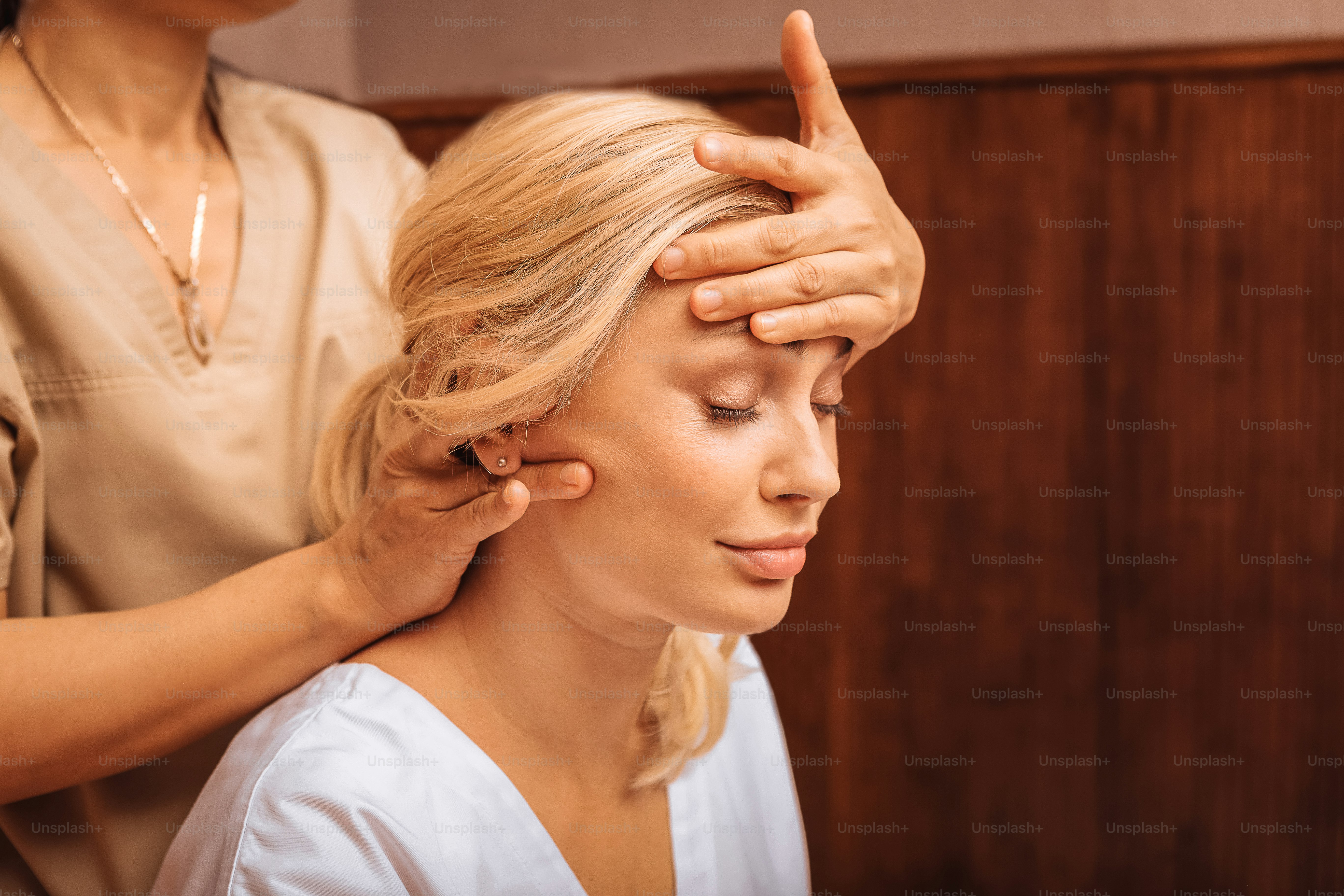 Wonderful relaxation. Face of a relaxed young woman having the massage ...