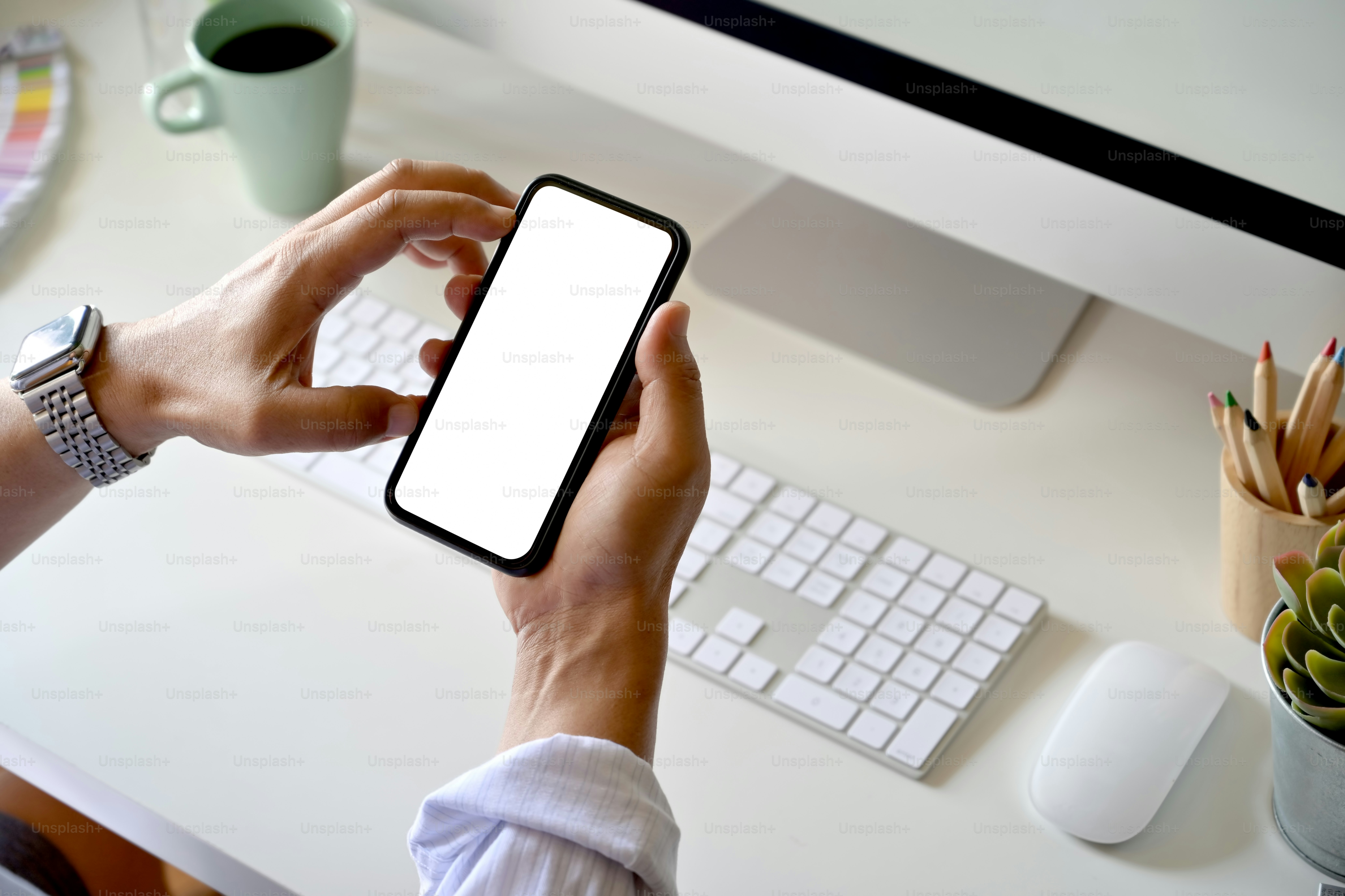 Cropped shot of young designer using blank screen mobile phone. photo ...