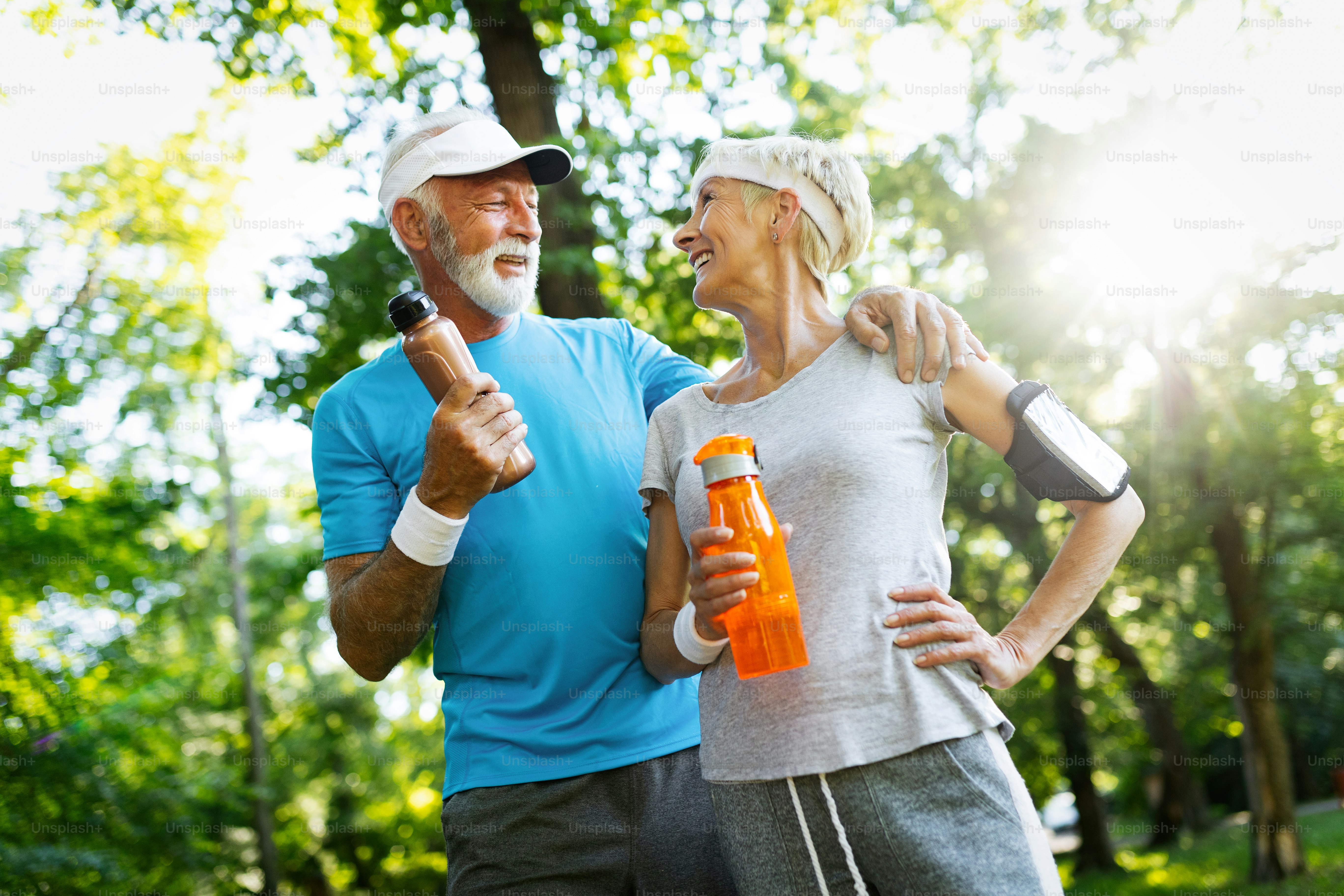 Happy fit senior couple exercising in outdoor park photo – Serbia Image ...