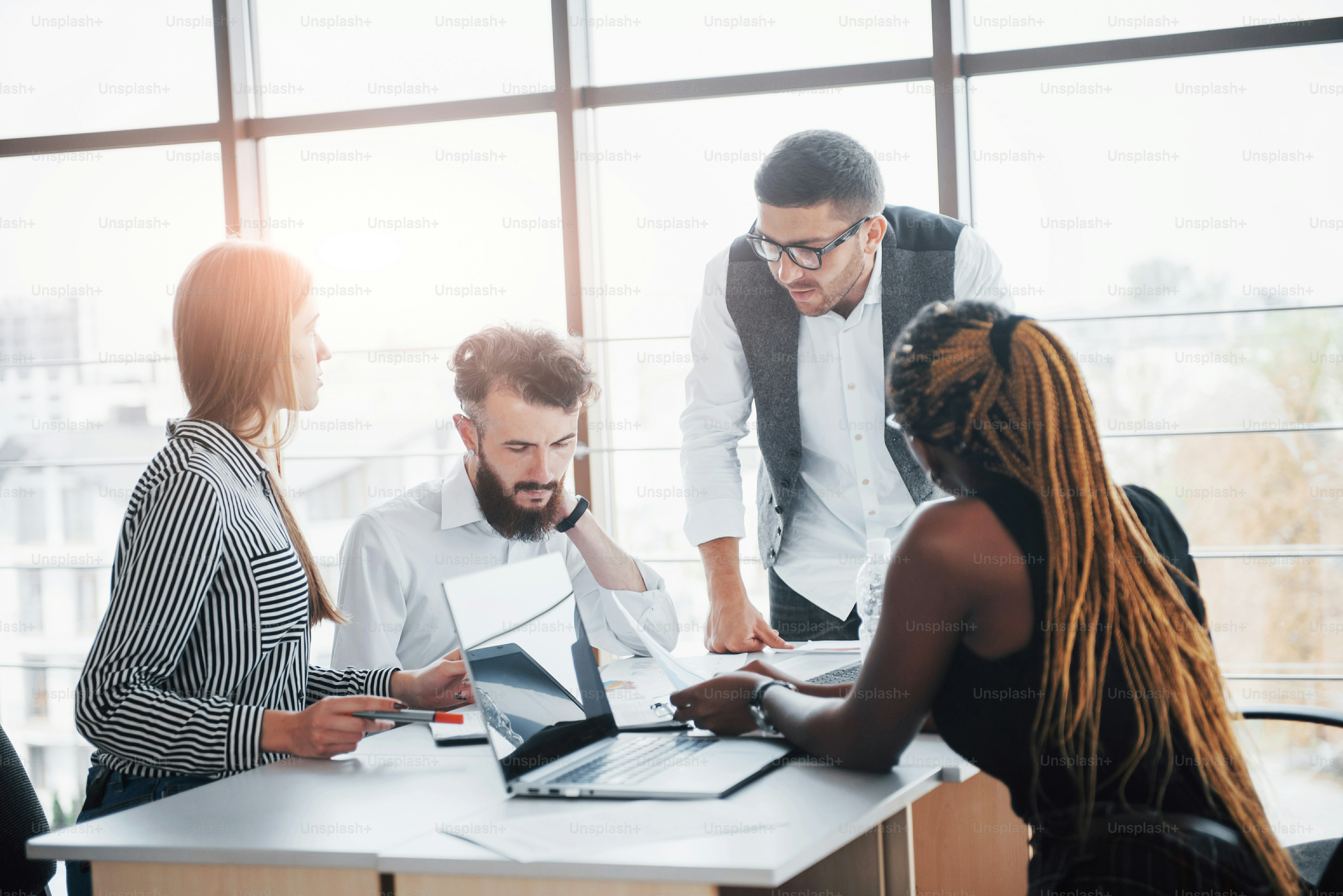 A group of multinational busy people working in the office. photo ...