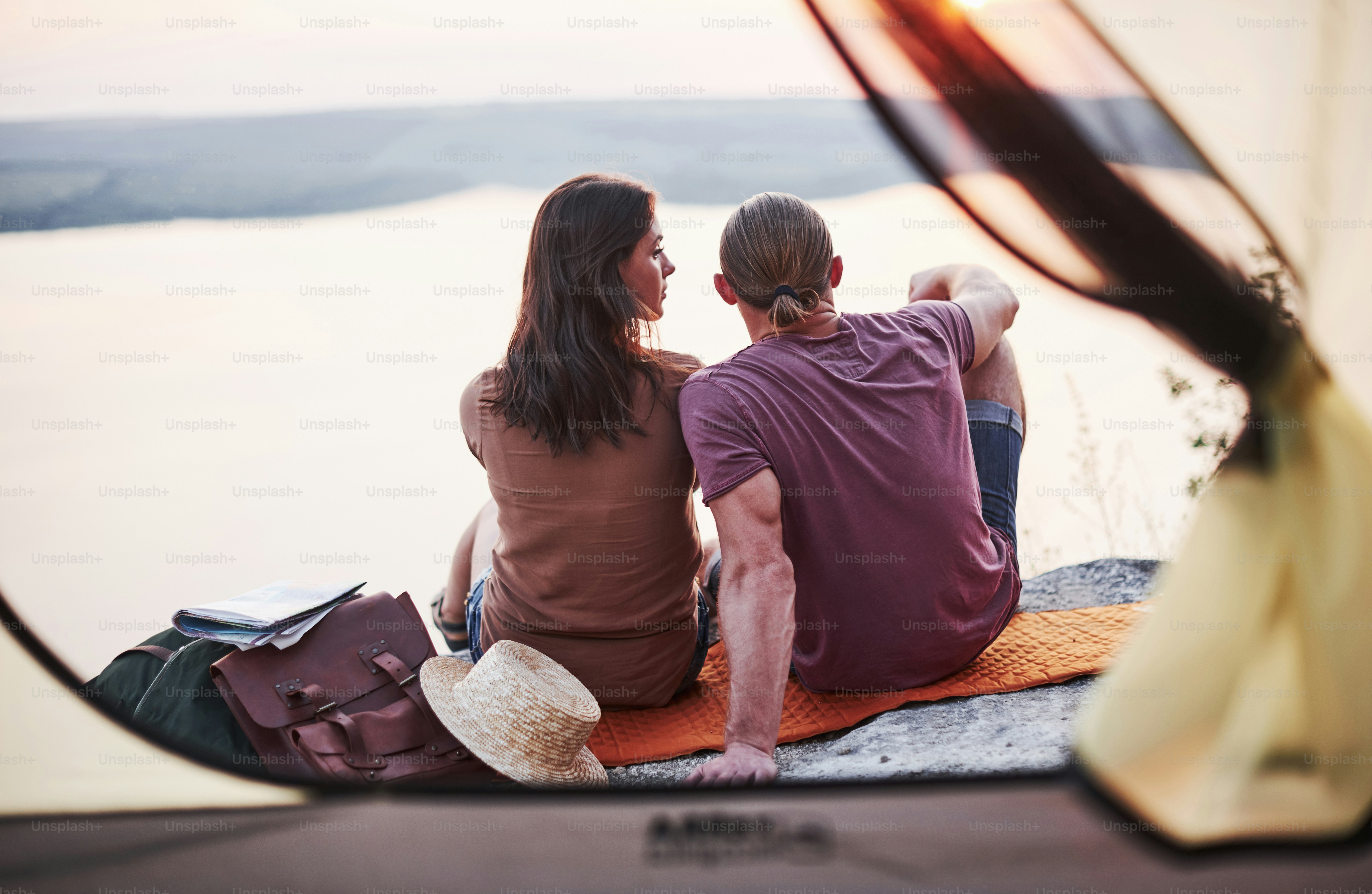 Two person sitting on the rock and watching gorgeous nature. photo ...