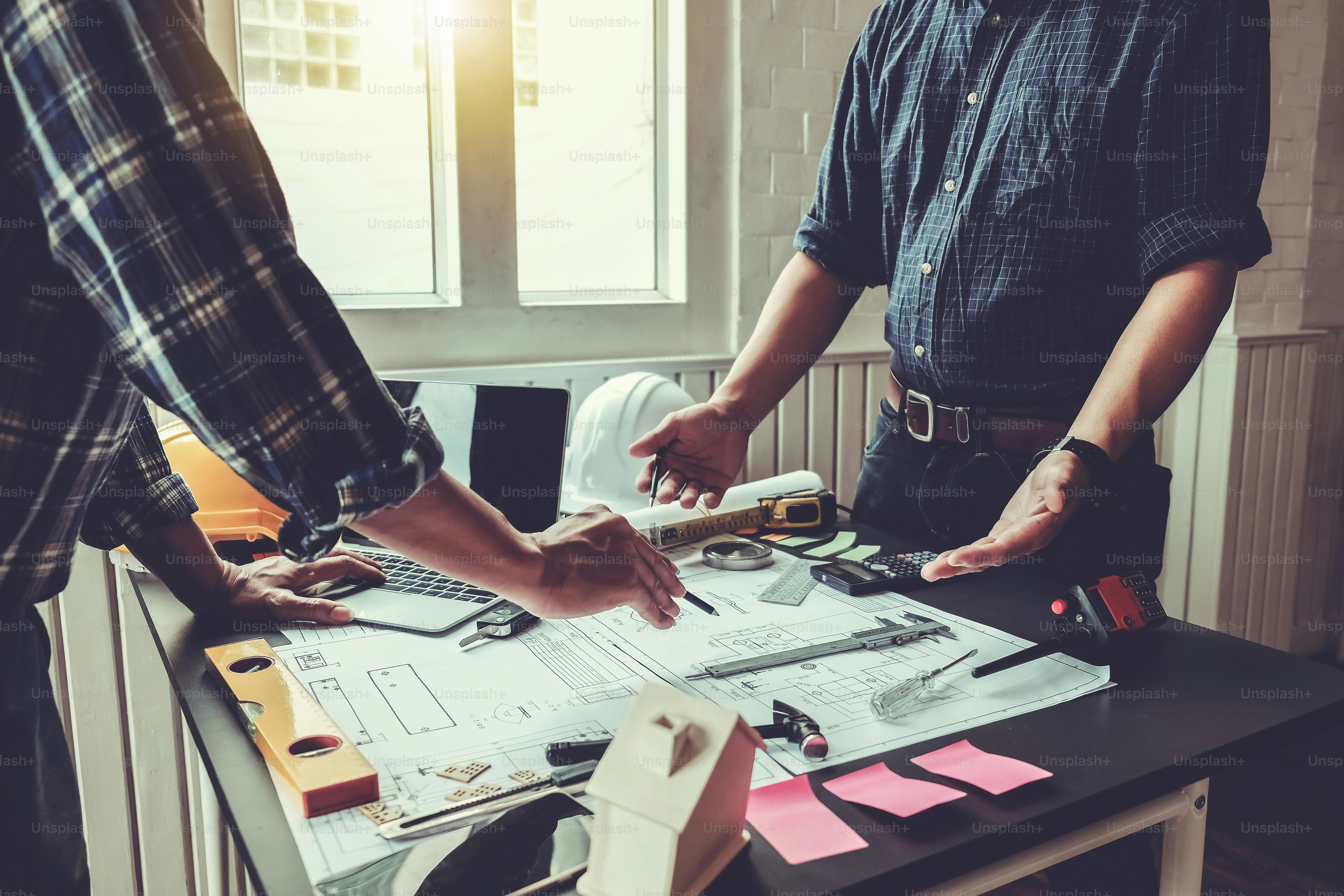Engineer and contractor planning projects together at the meeting ...