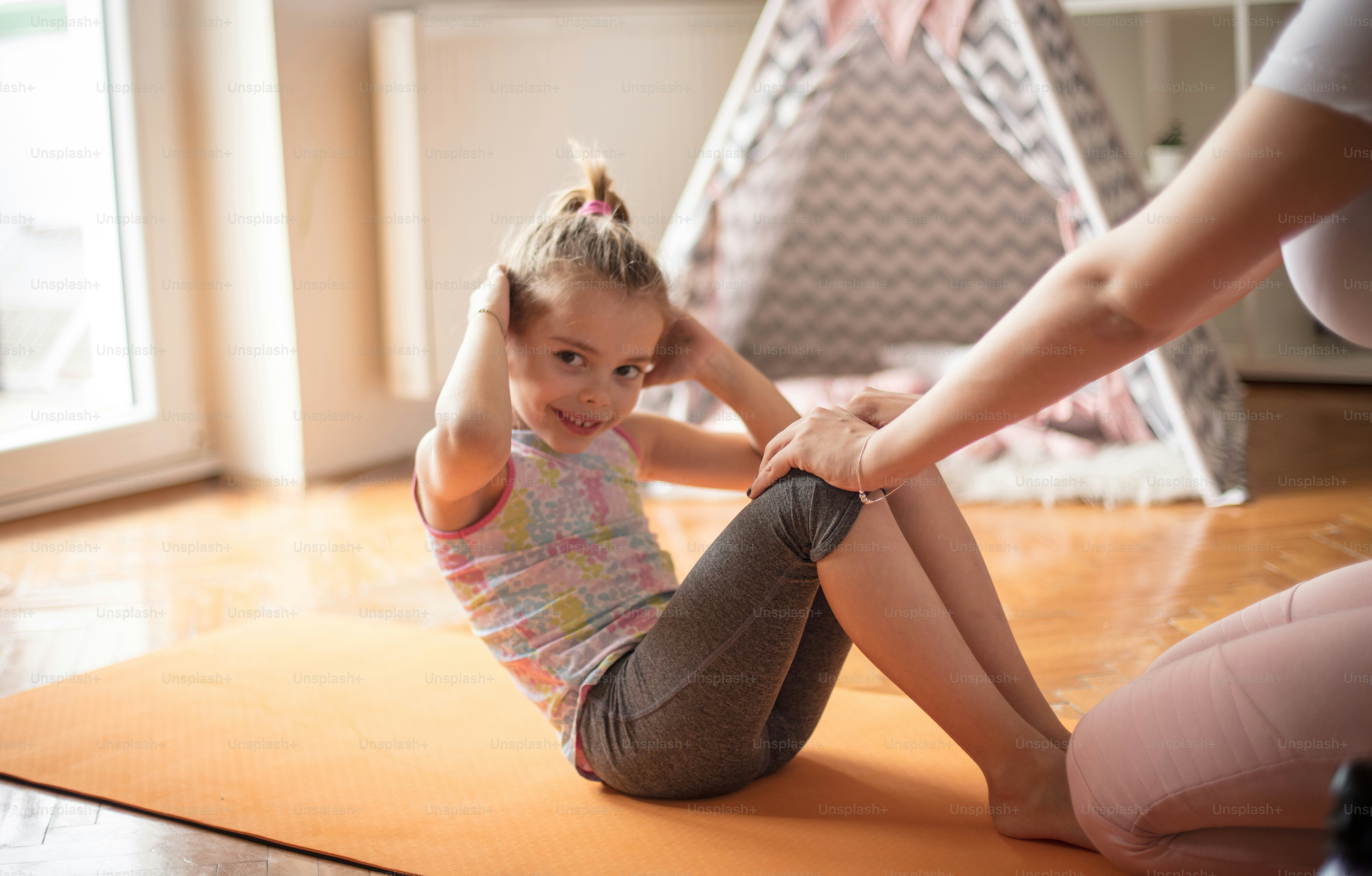 My mom is my helper. Mother helping her daughter in exercise. photo ...