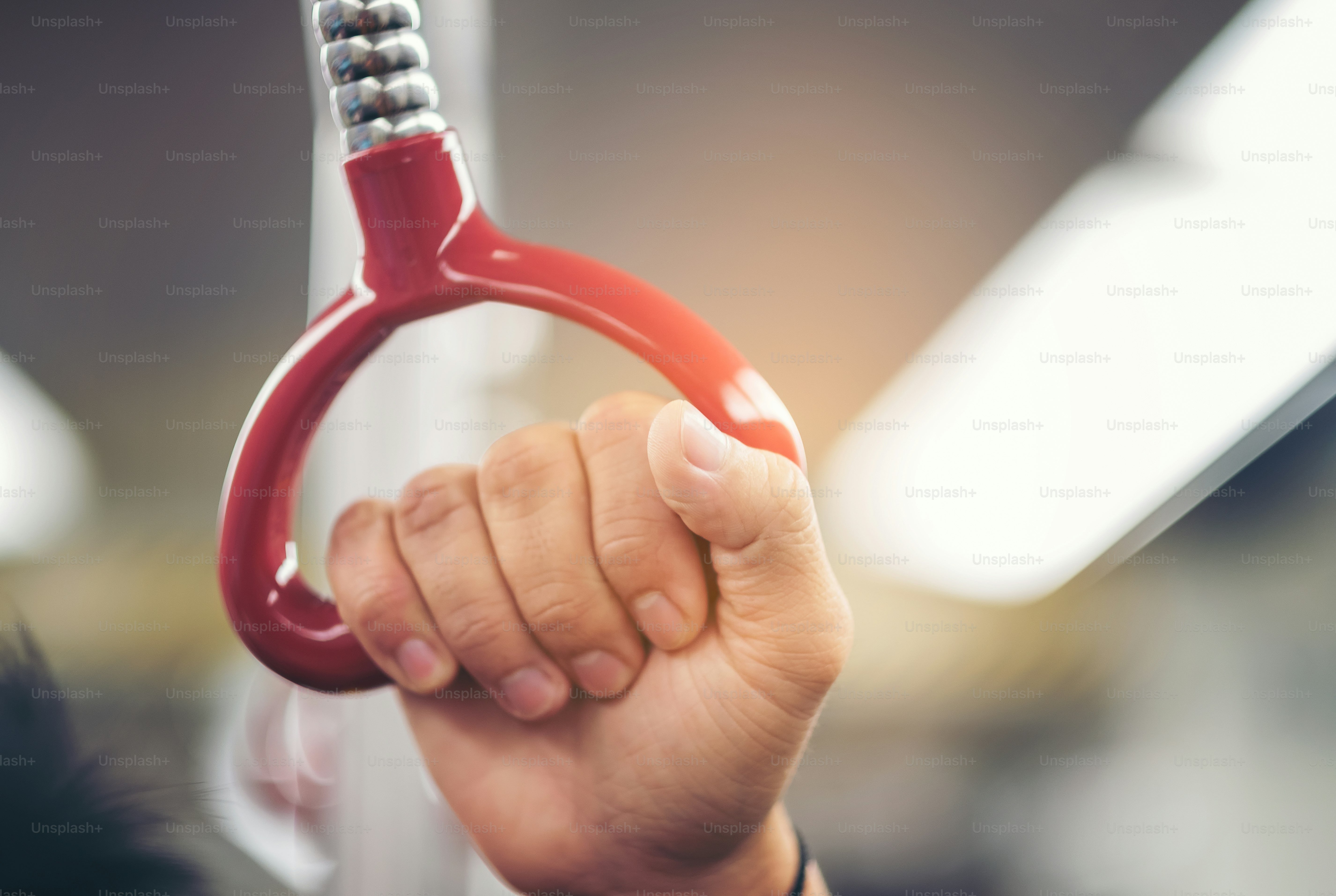 People holding hand onto a handle on a train photo – Gripping Image on ...