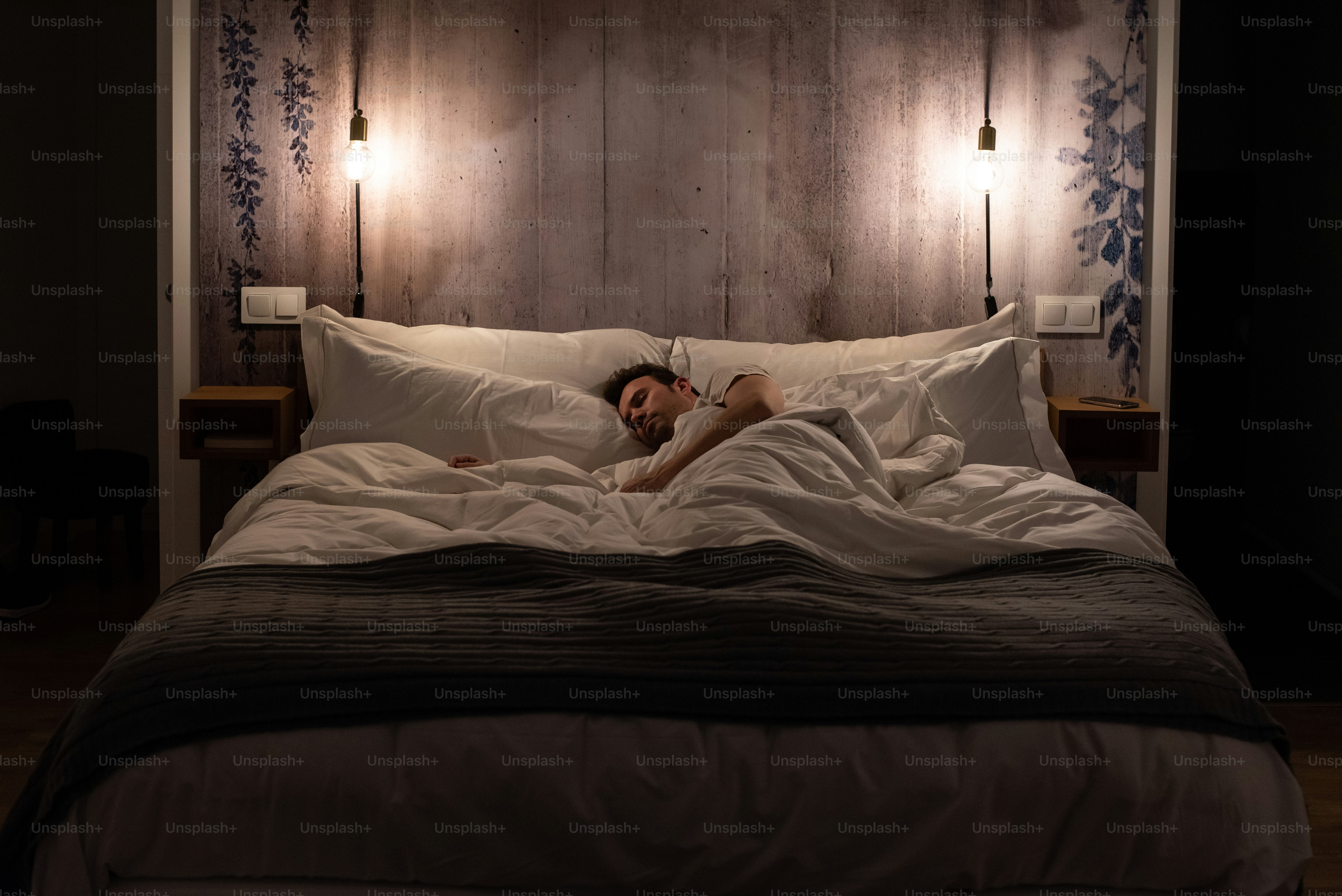 Man sleeping in bed in a modern beautiful bedroom photo – Black room ...