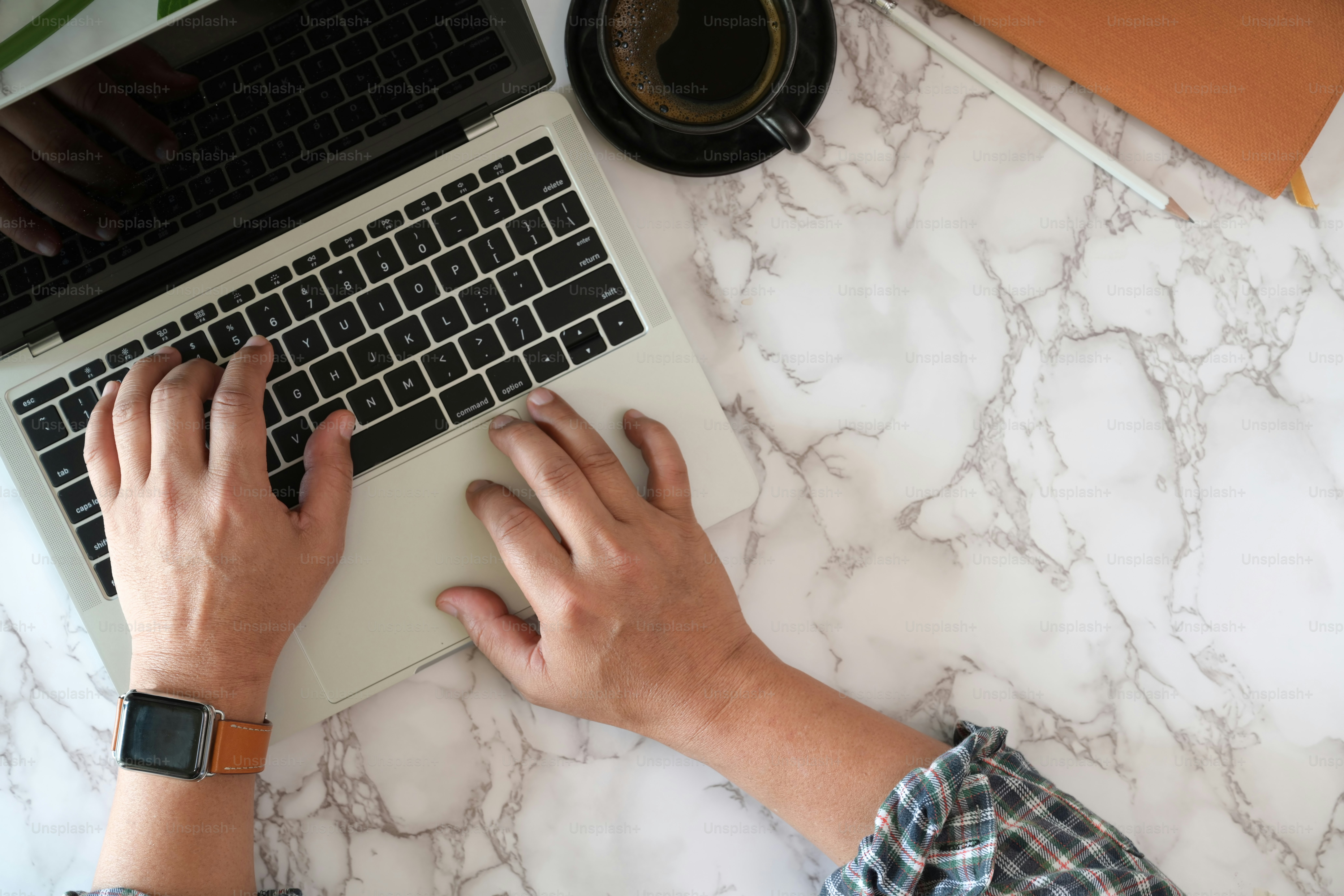 Top view of male worker typing on laptop on marble desk photo ...