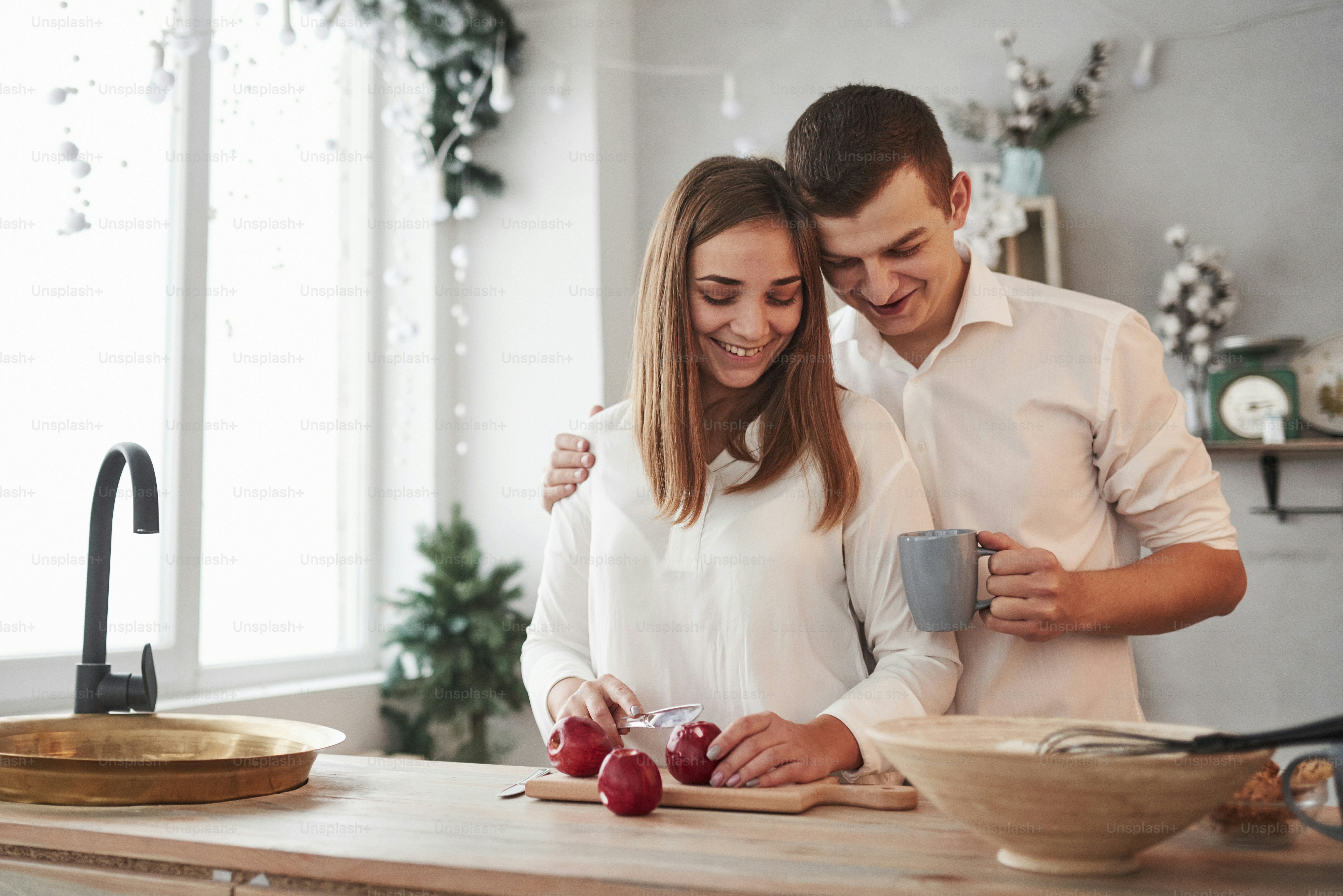 Girl slice the apples. Having nice time together on the kitchen on ...