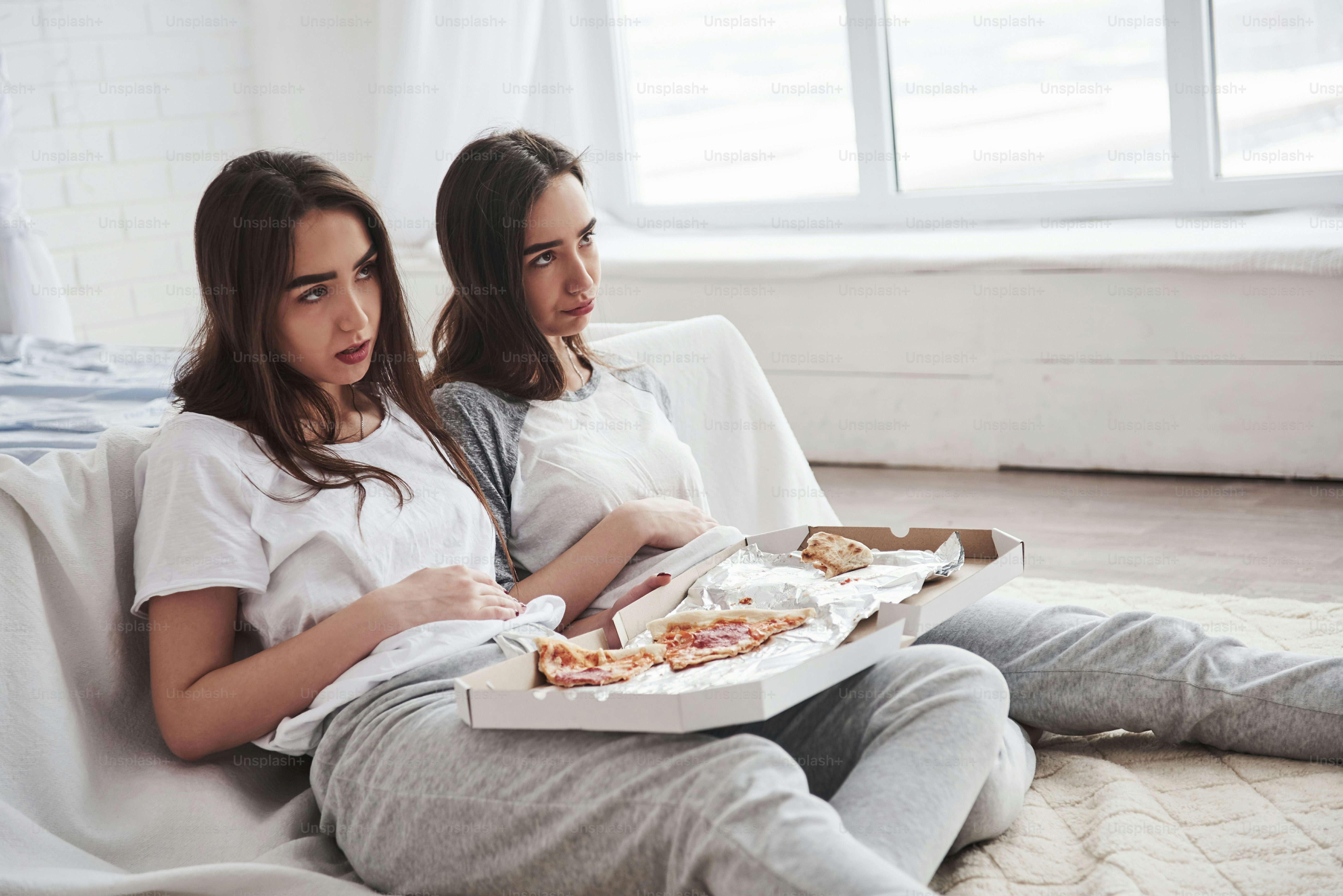 Suffers from overeating. Twins have full stomach with pizza. Nice ...