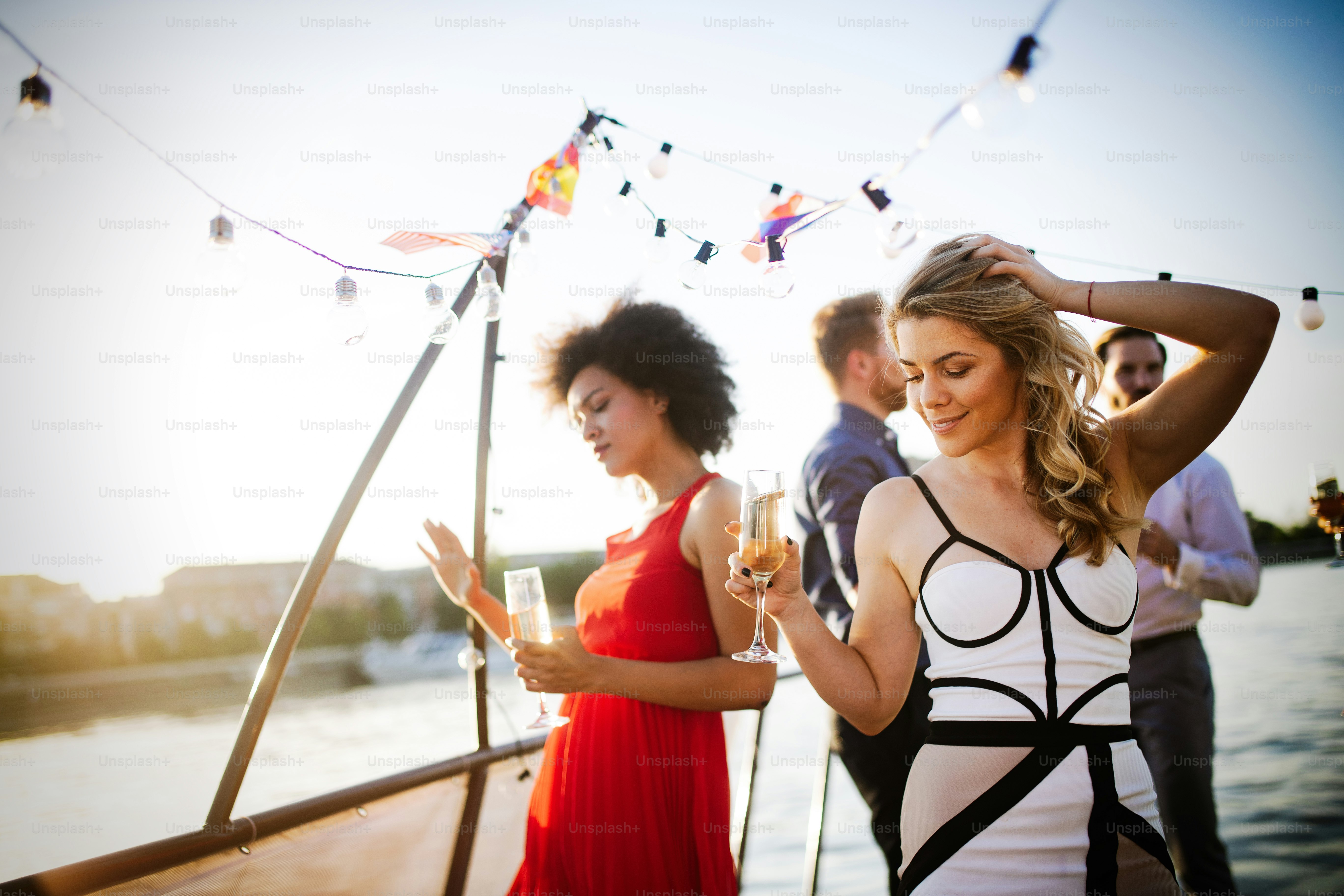 Group of friends drinking, dancing and having a fun at outdoor party ...