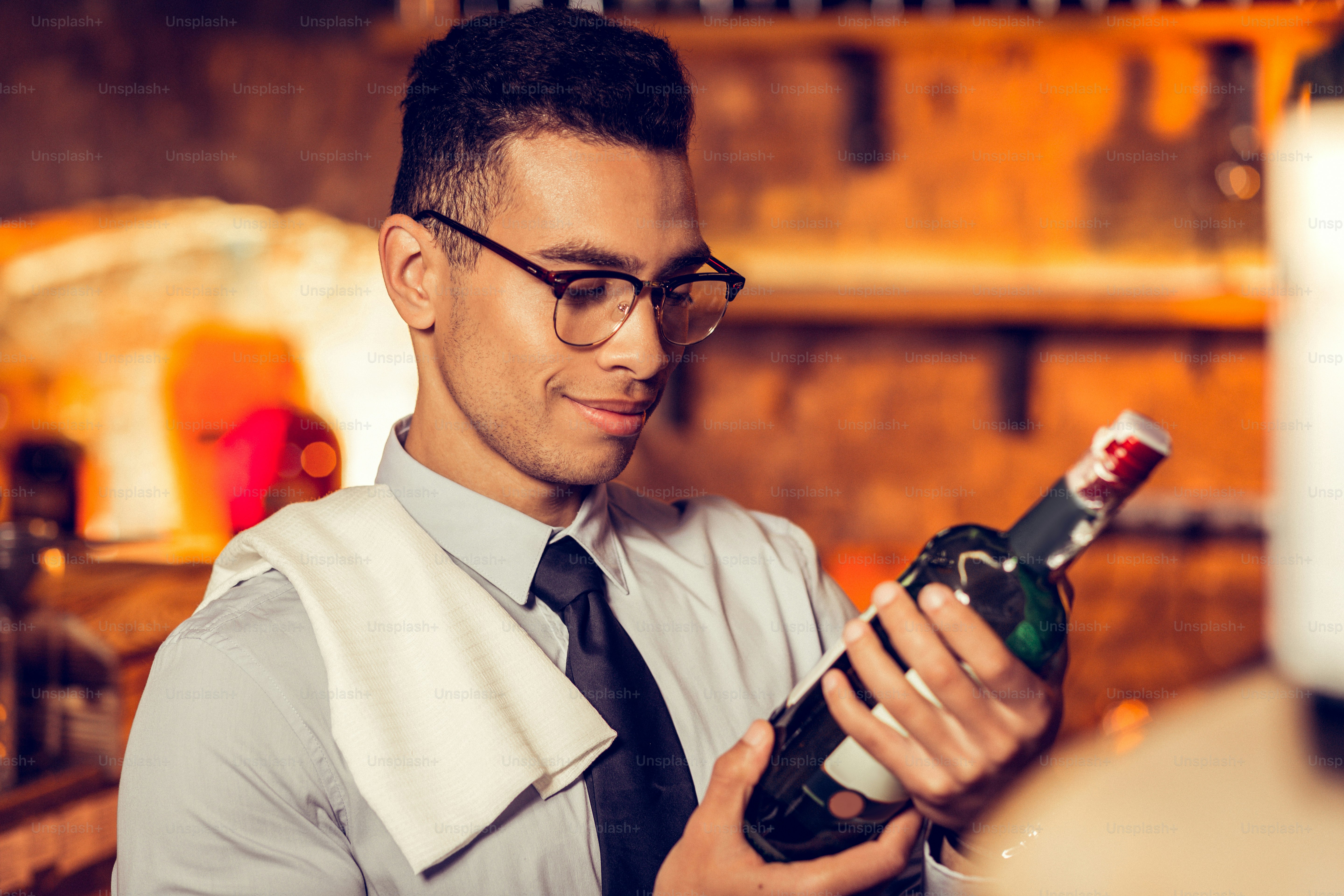 French wine. Dark-haired prosperous man wearing glasses looking at ...