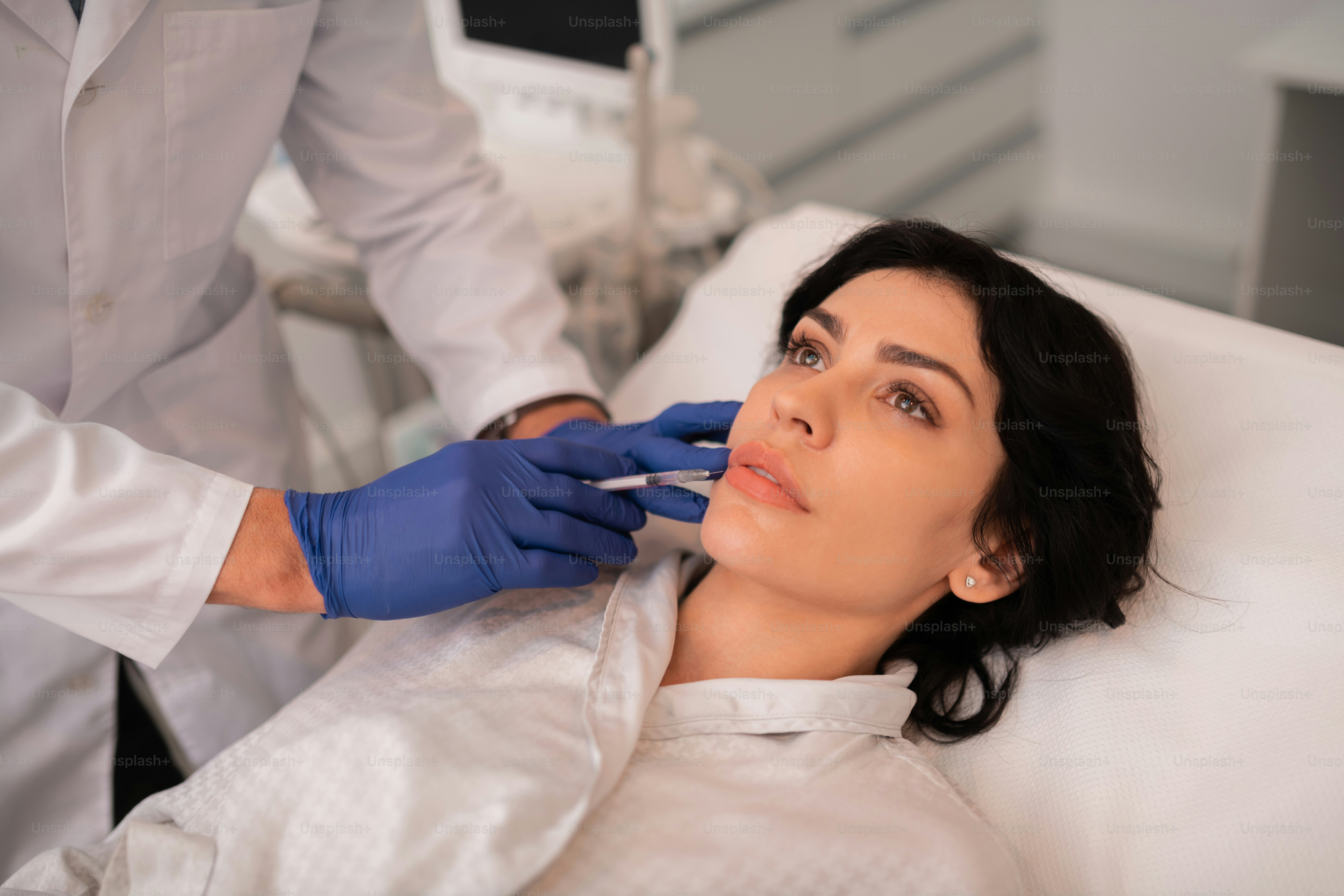 Having botox injections. Beautiful businesswoman having botox ...