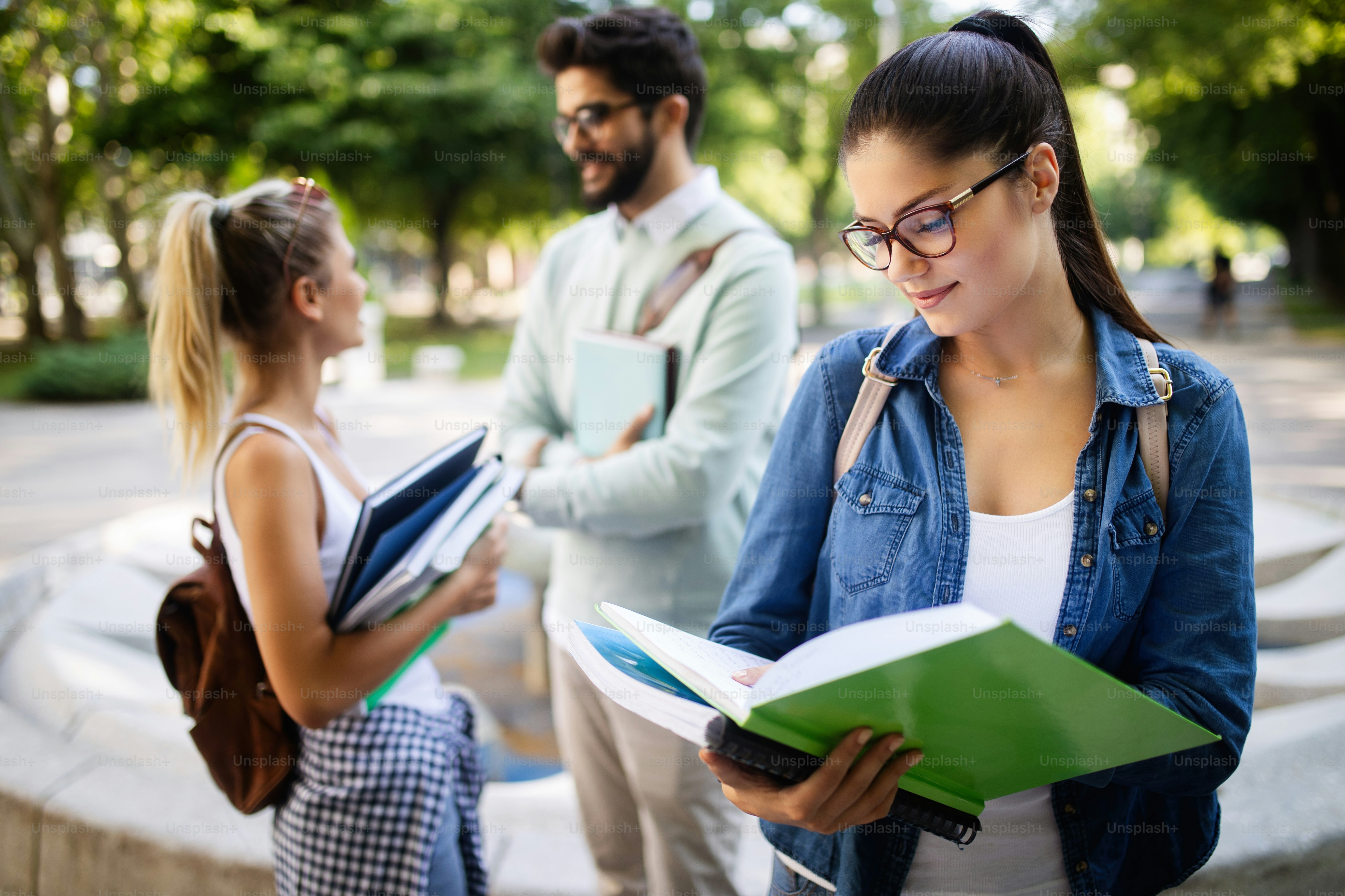 Happy young university students studying together. Group of multiracial ...