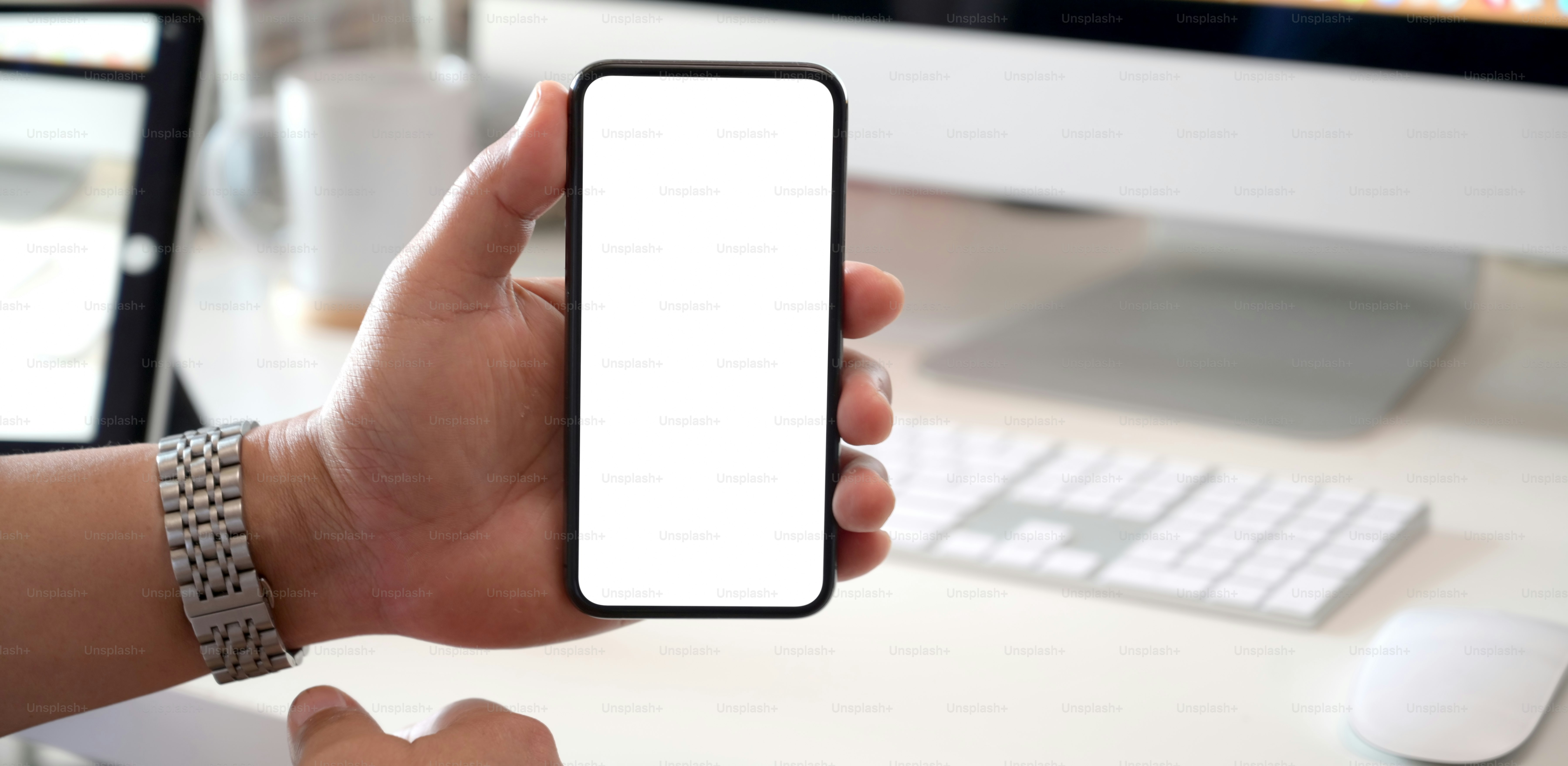 Businessman using mobile phone mock up blank screen display in office ...