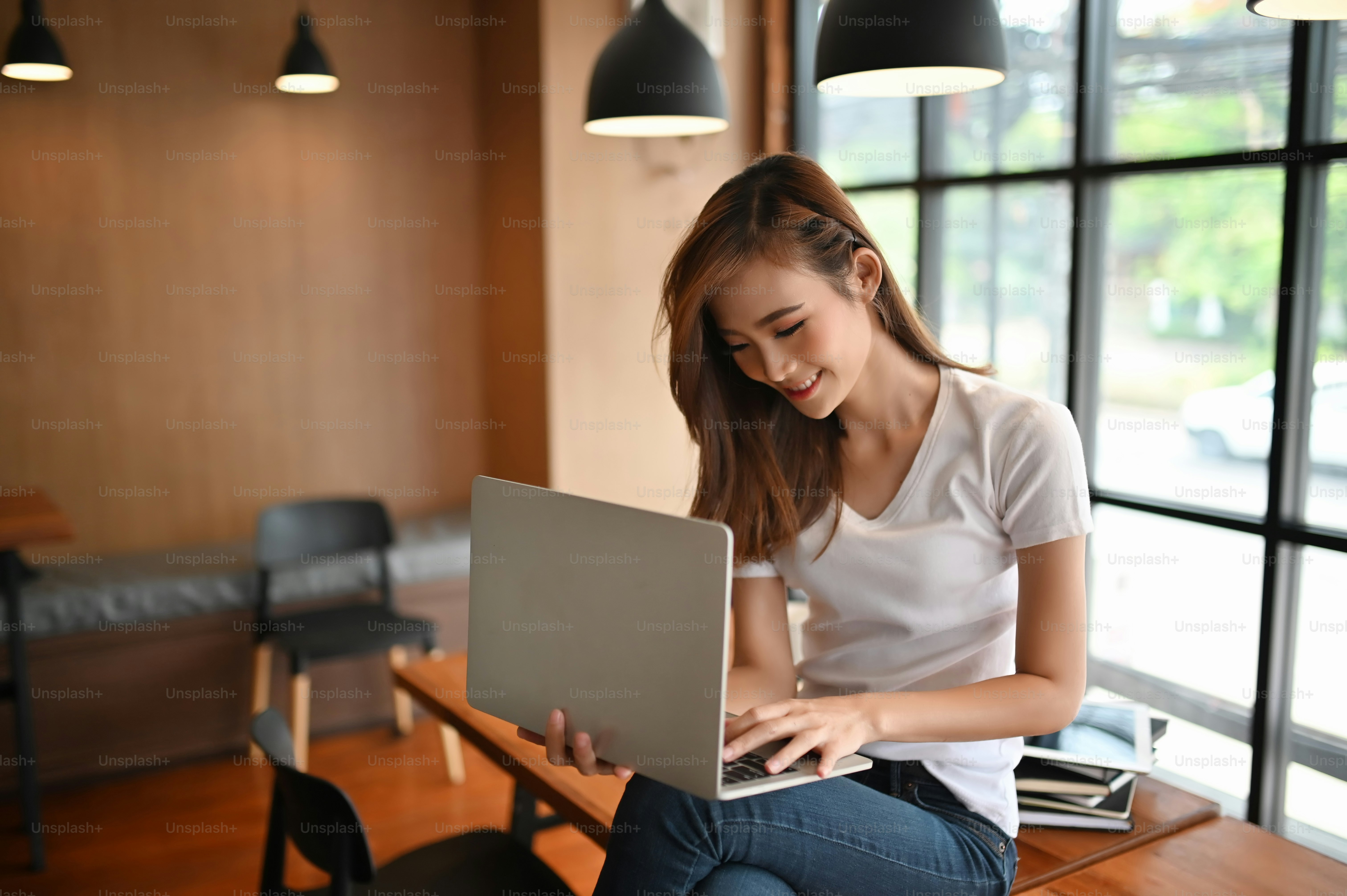 Women using laptop computer and sitting on table. photo – Sitting Image ...