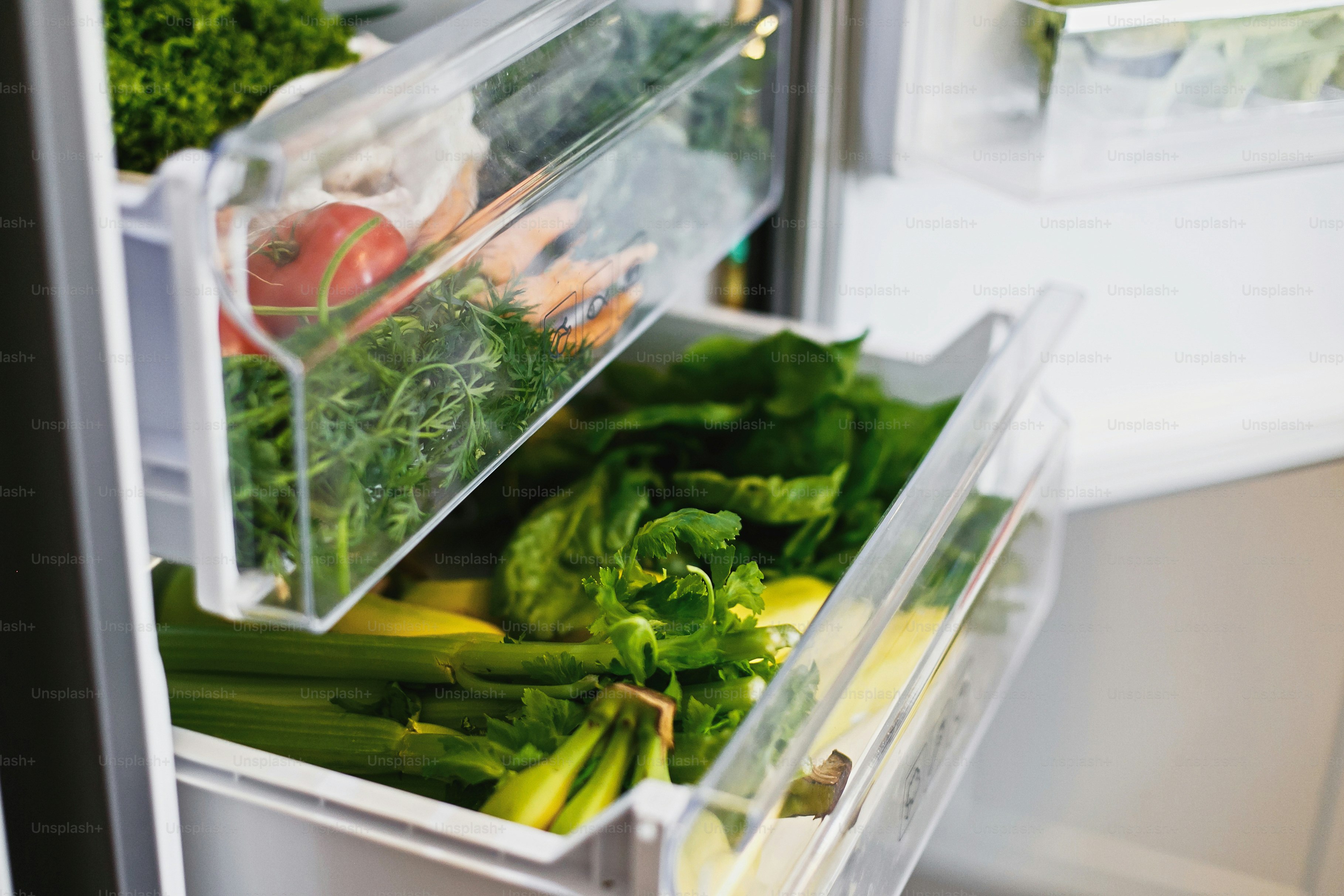 Zero waste grocery in fridge. Fresh vegetables in opened drawer in ...