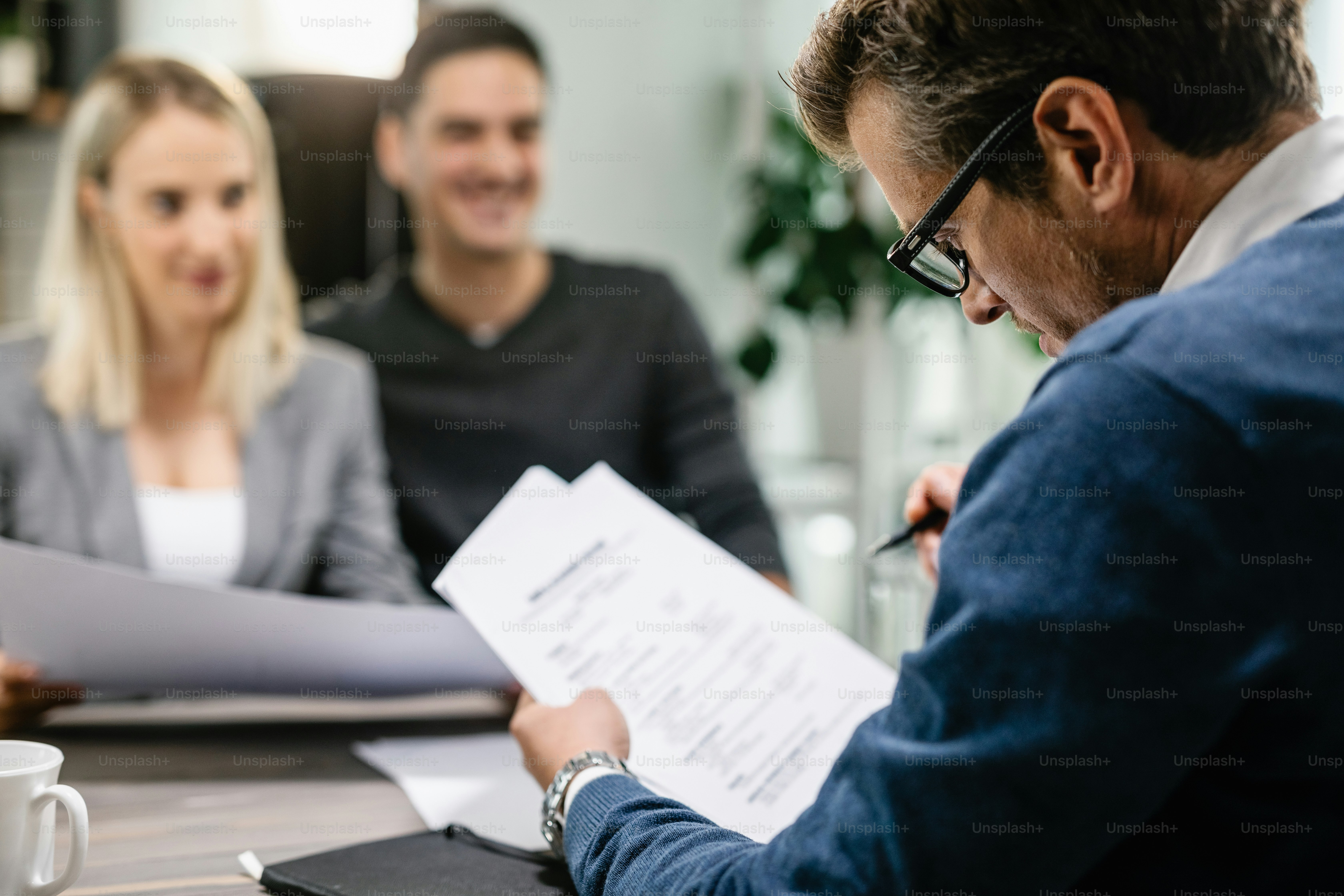 Insurance agent going through paperwork during the meeting with a ...