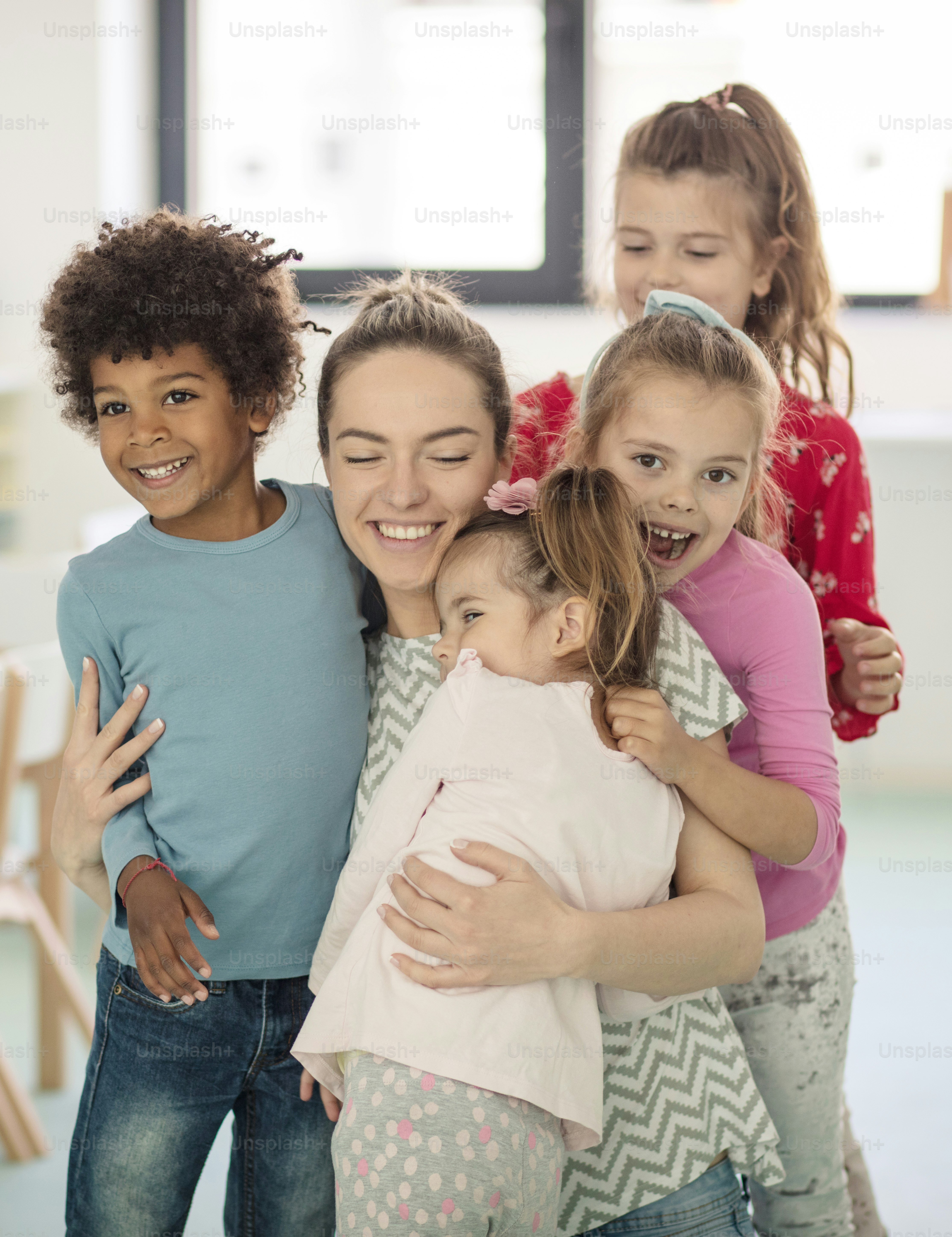 Share hugs. Children in preschool. photo – Child care Image on Unsplash