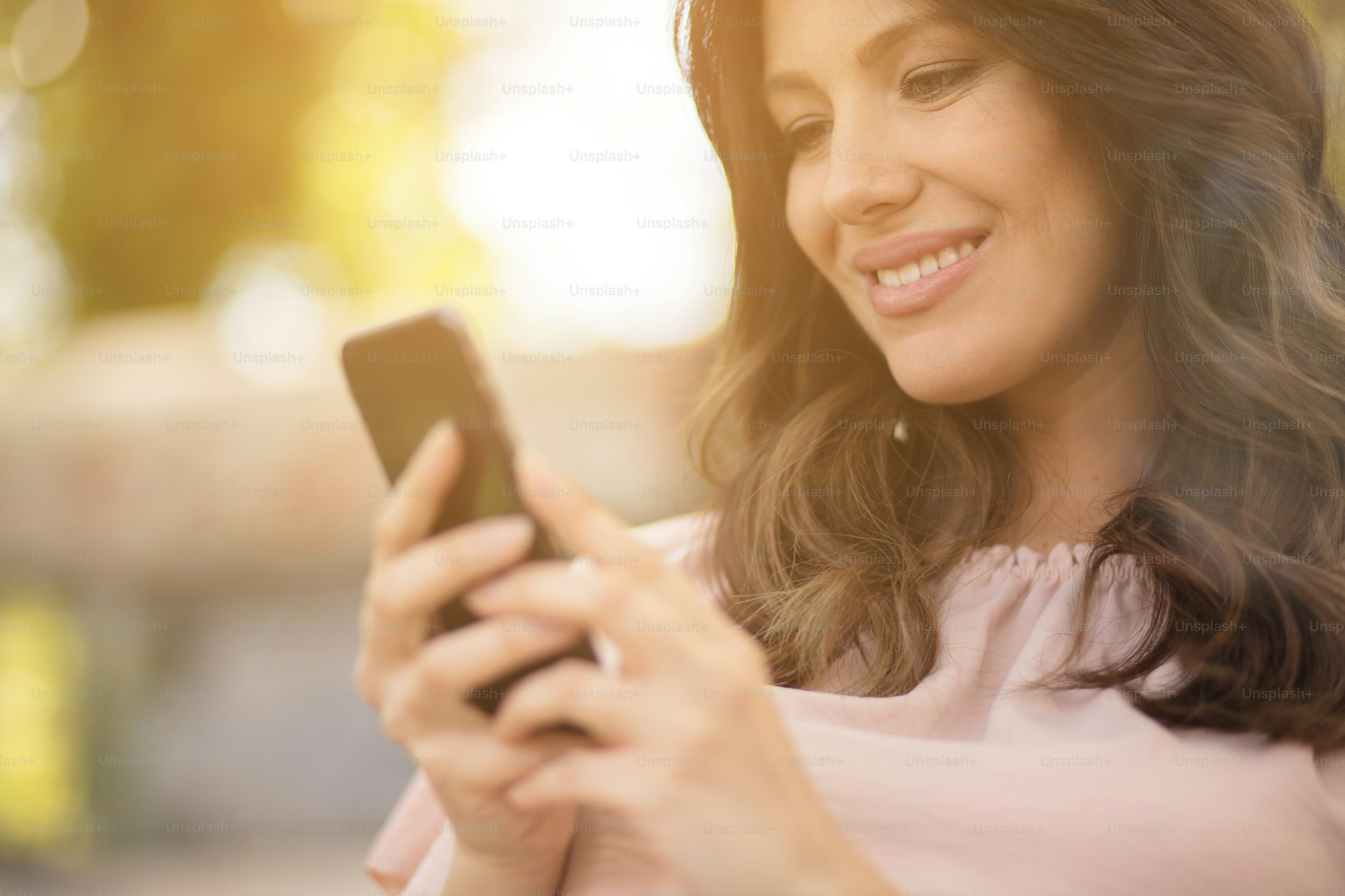 Status update: In the nature. Beauty woman in nature using smart phone ...