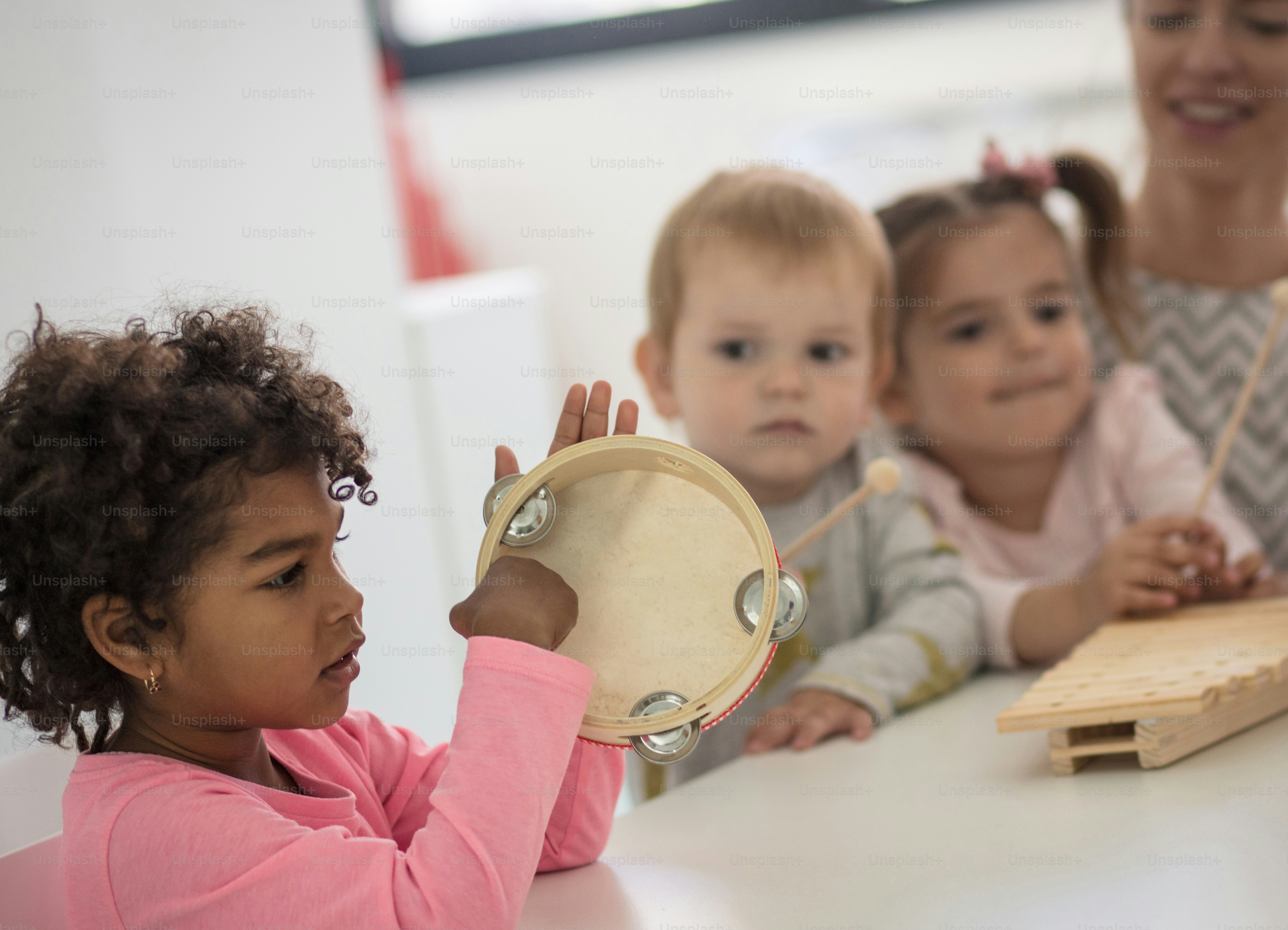 Everybody is jamming together. Children in preschool. photo – Ethnicity ...