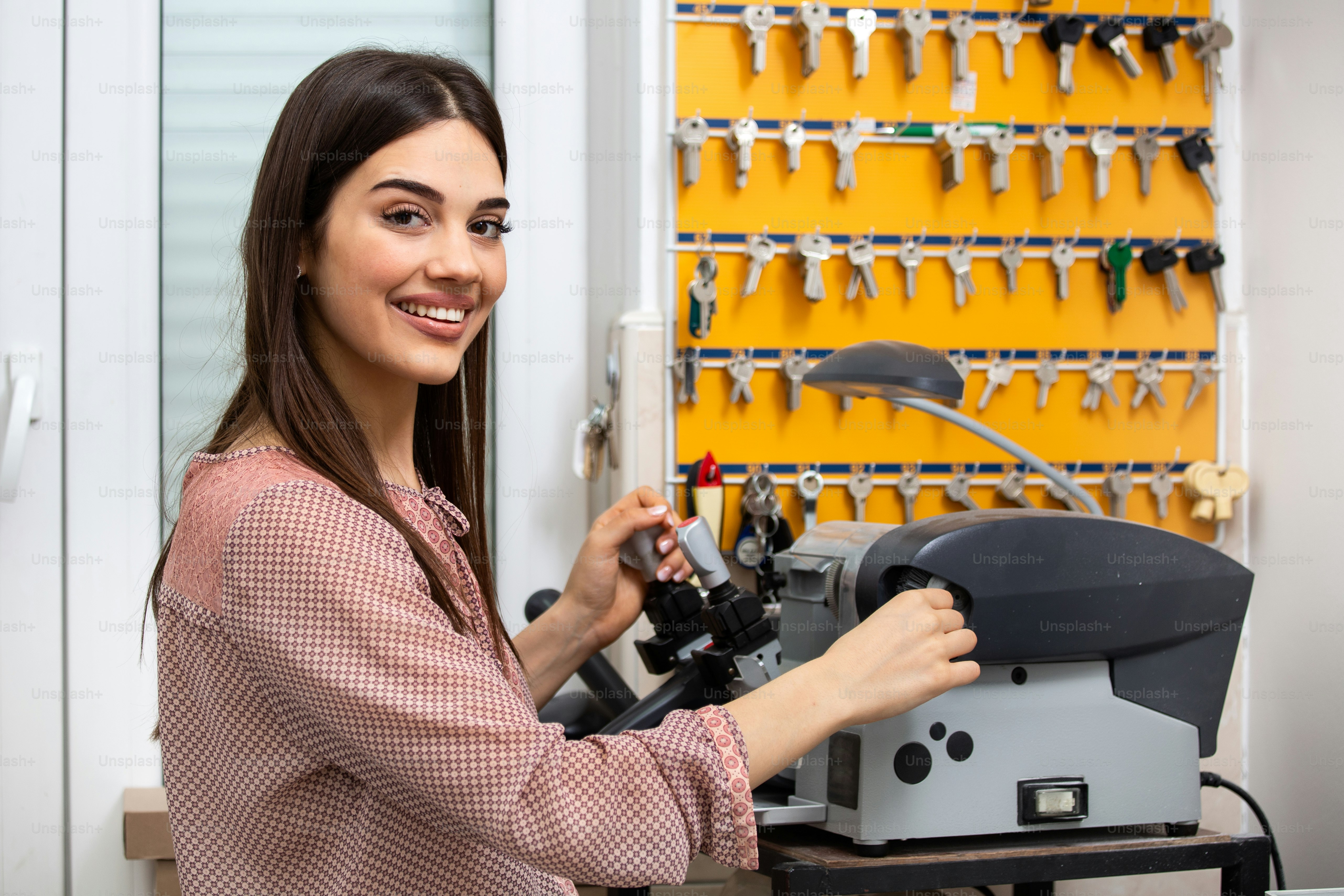 Professional skilled key cutter making door keys copies in locksmith ...