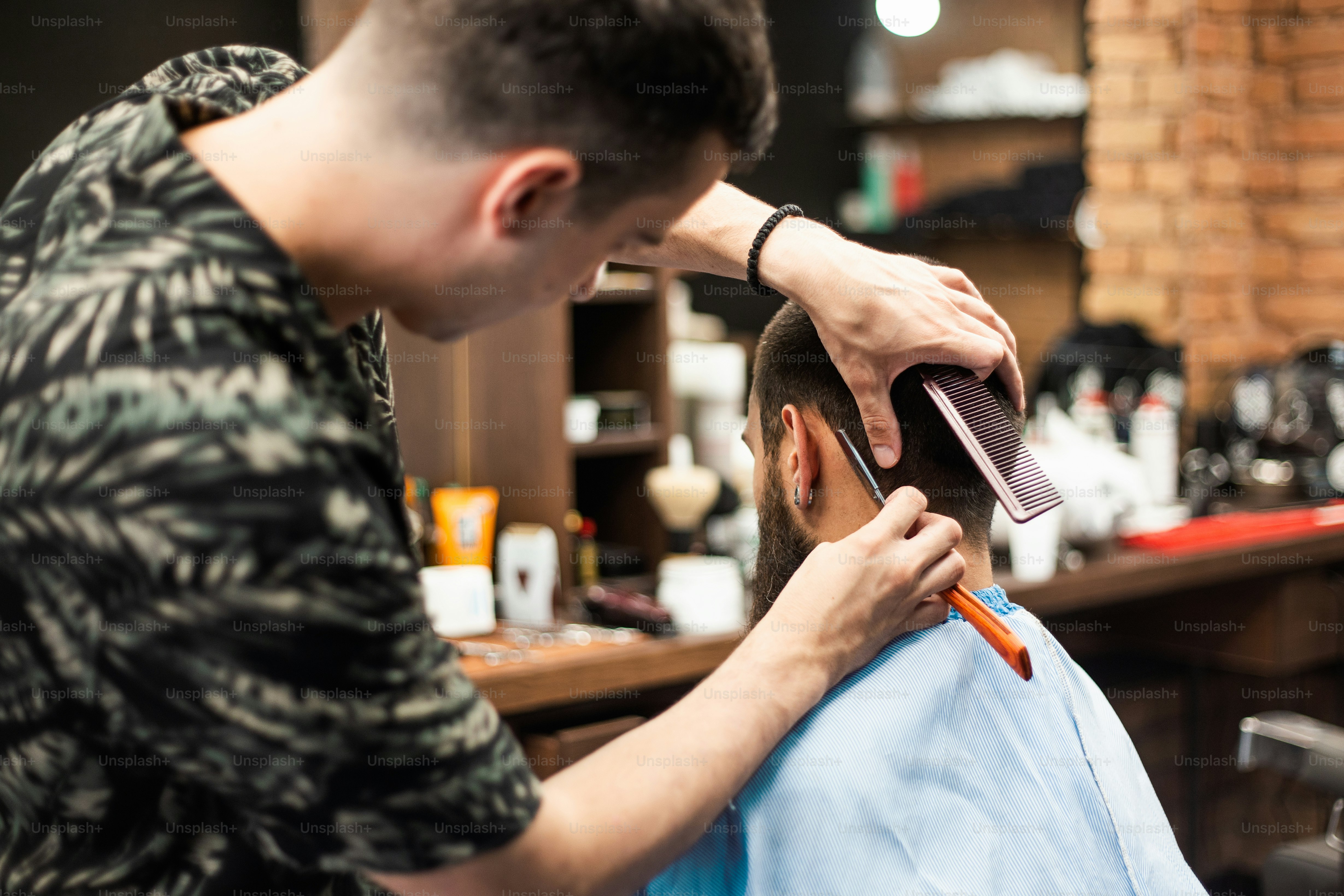 Razor in hands of professional barber. Hairdresser shaving man's neck ...