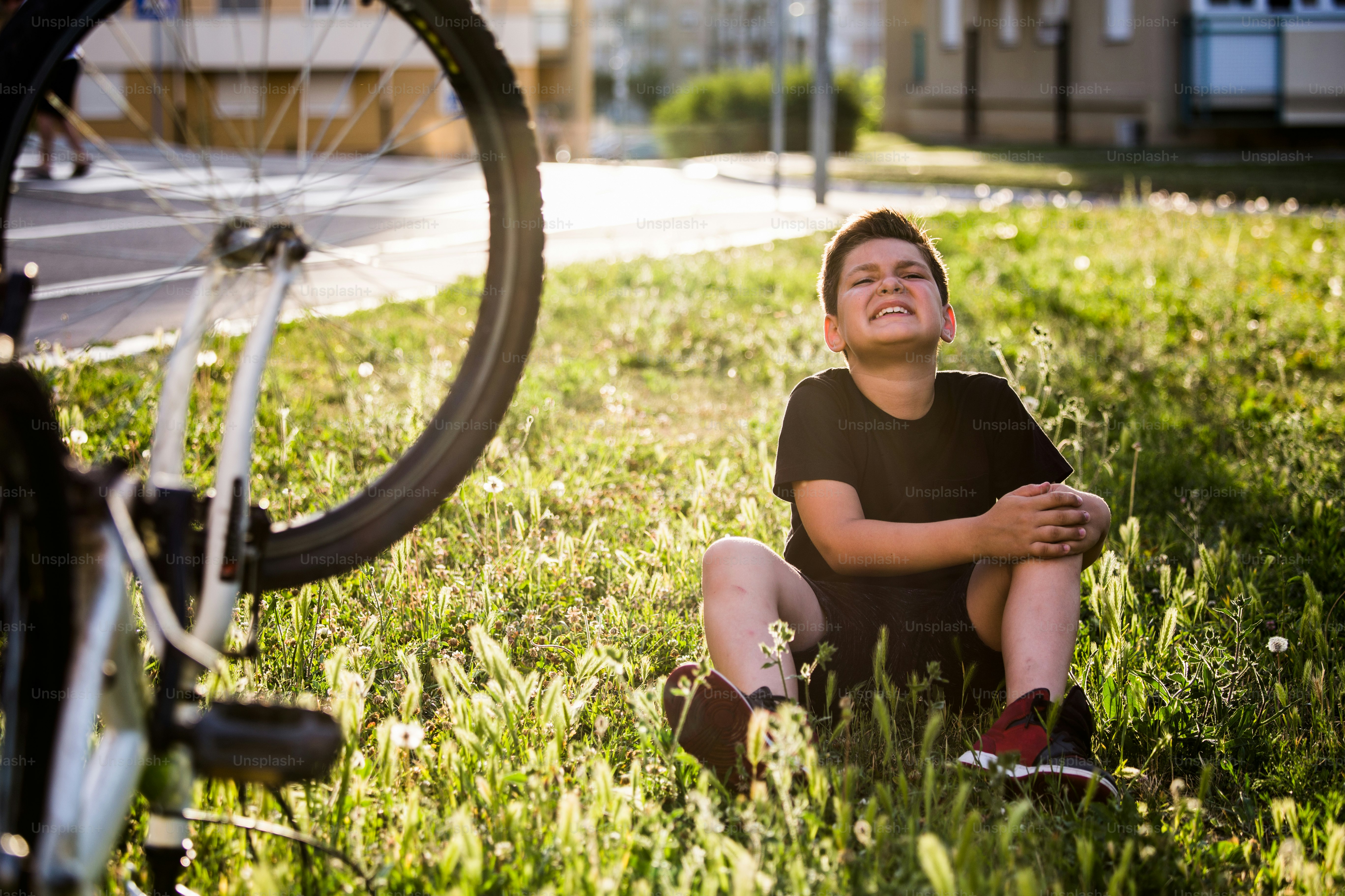 Teenage boy There is a knee injury, as the bike falls while riding. Kid ...