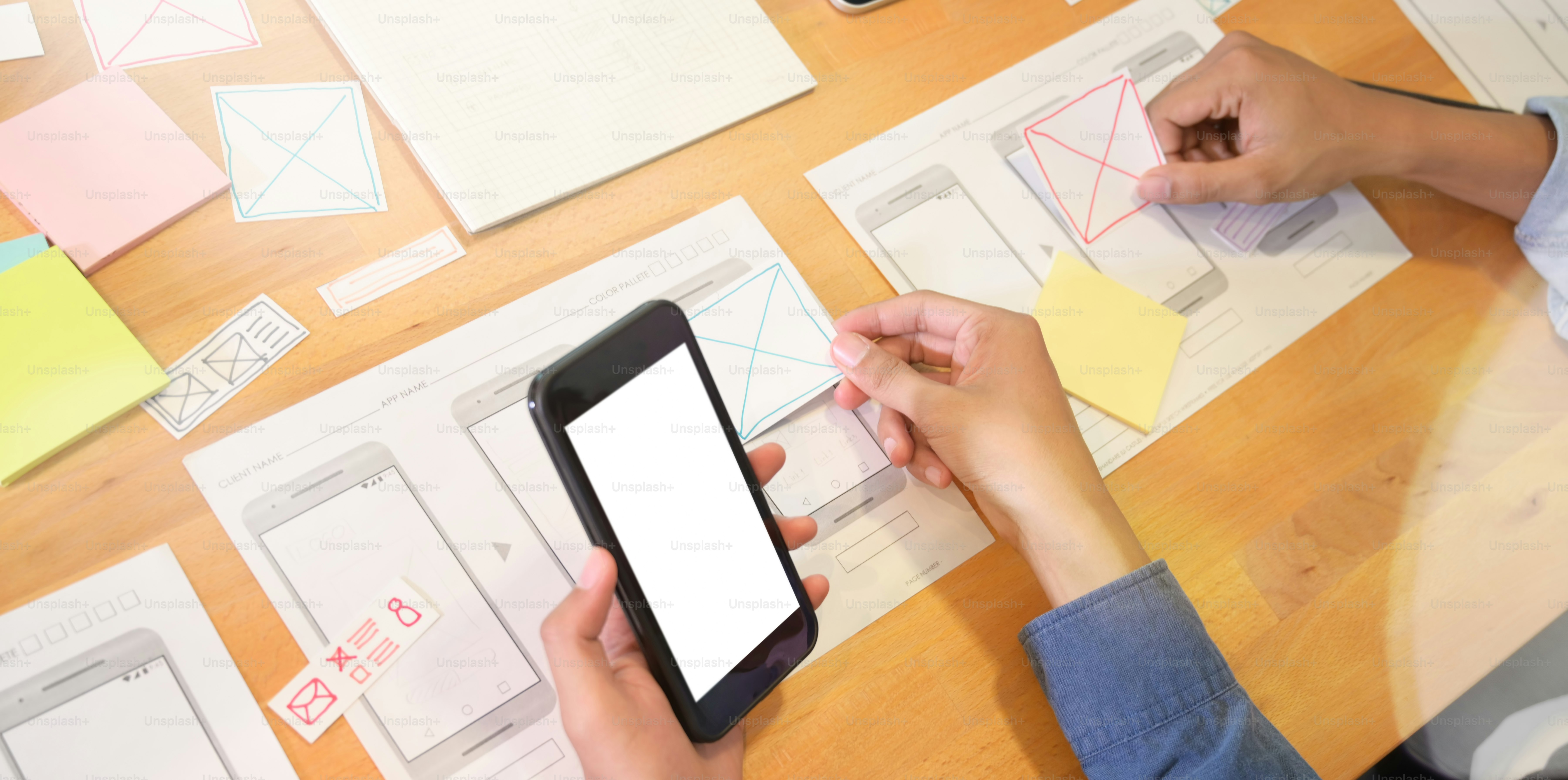 Close-up view of successful web designers working on user interface ...