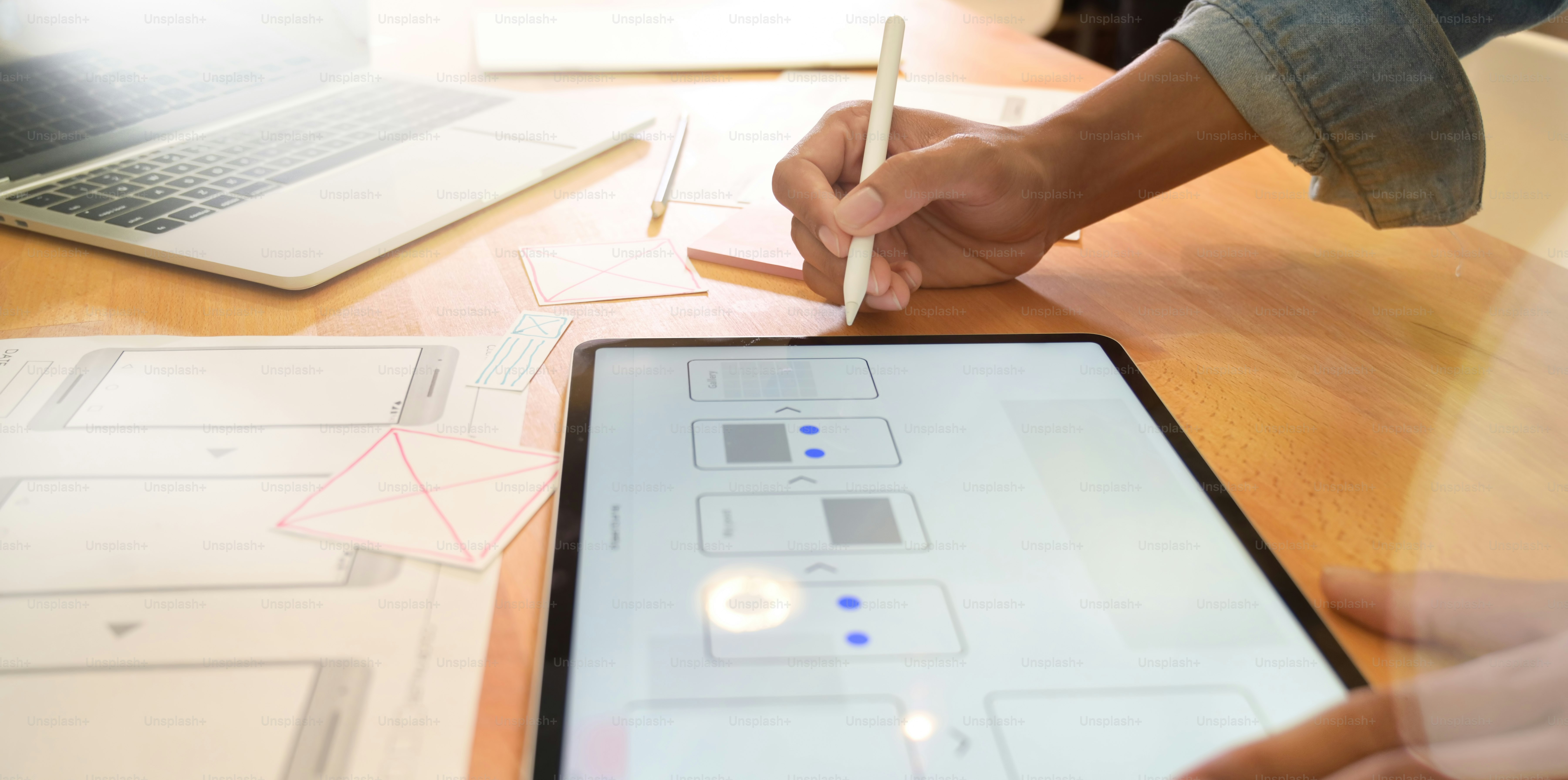 Close-up view of web developer designs UI templates on tablet photo ...
