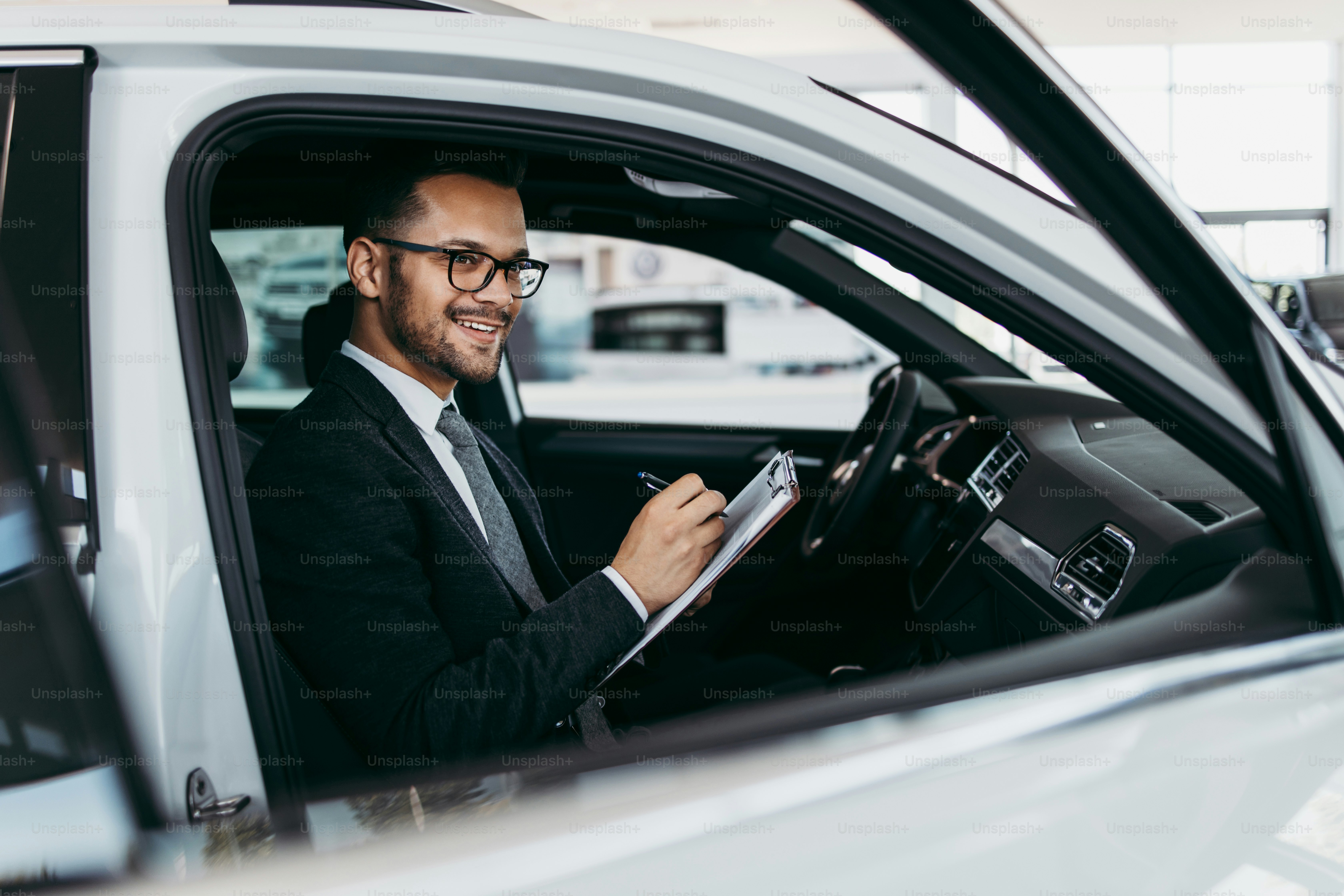 Car seller working in showroom and quality control checking of car ...