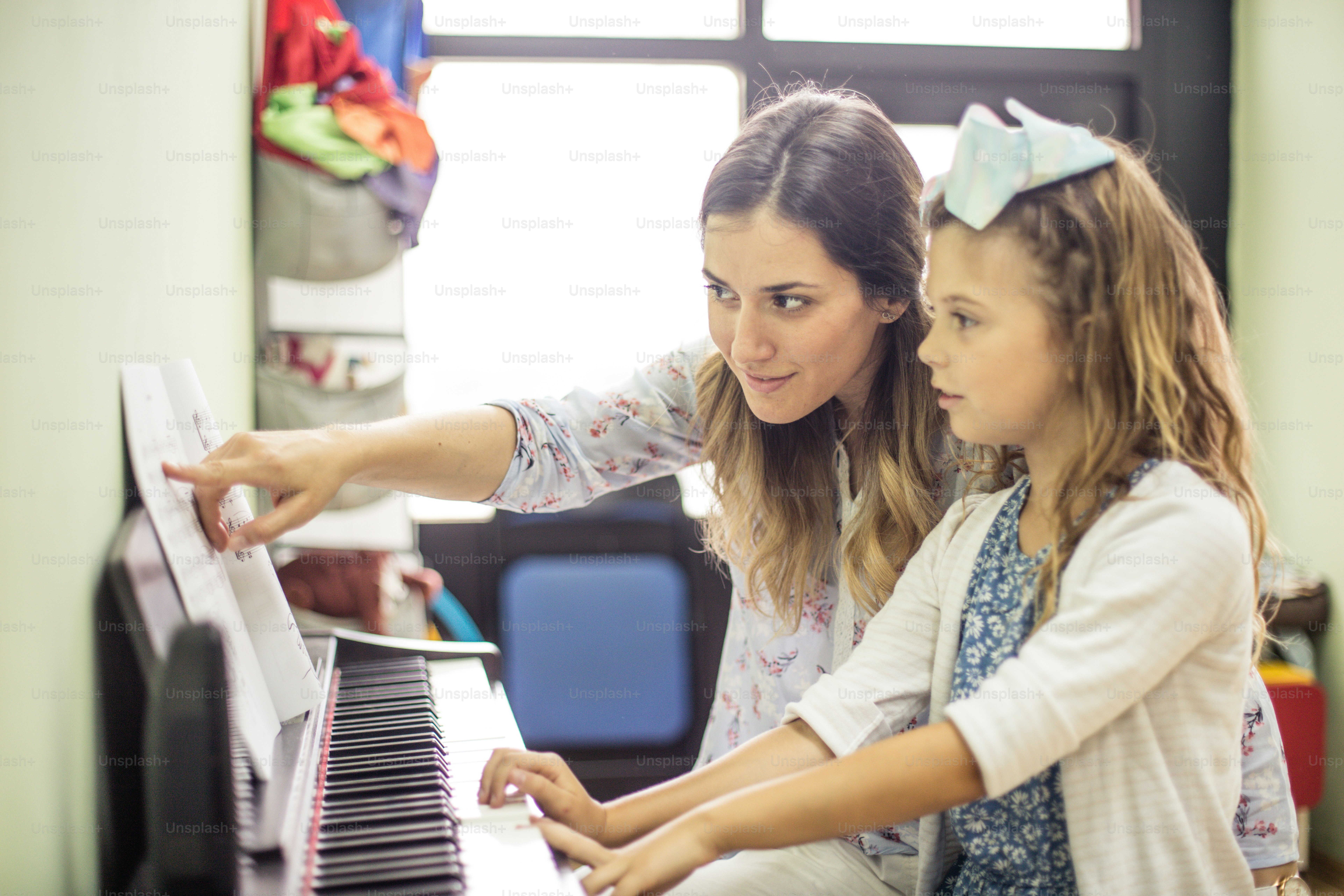Miniature maestro. Child in music school with teacher. photo – People ...