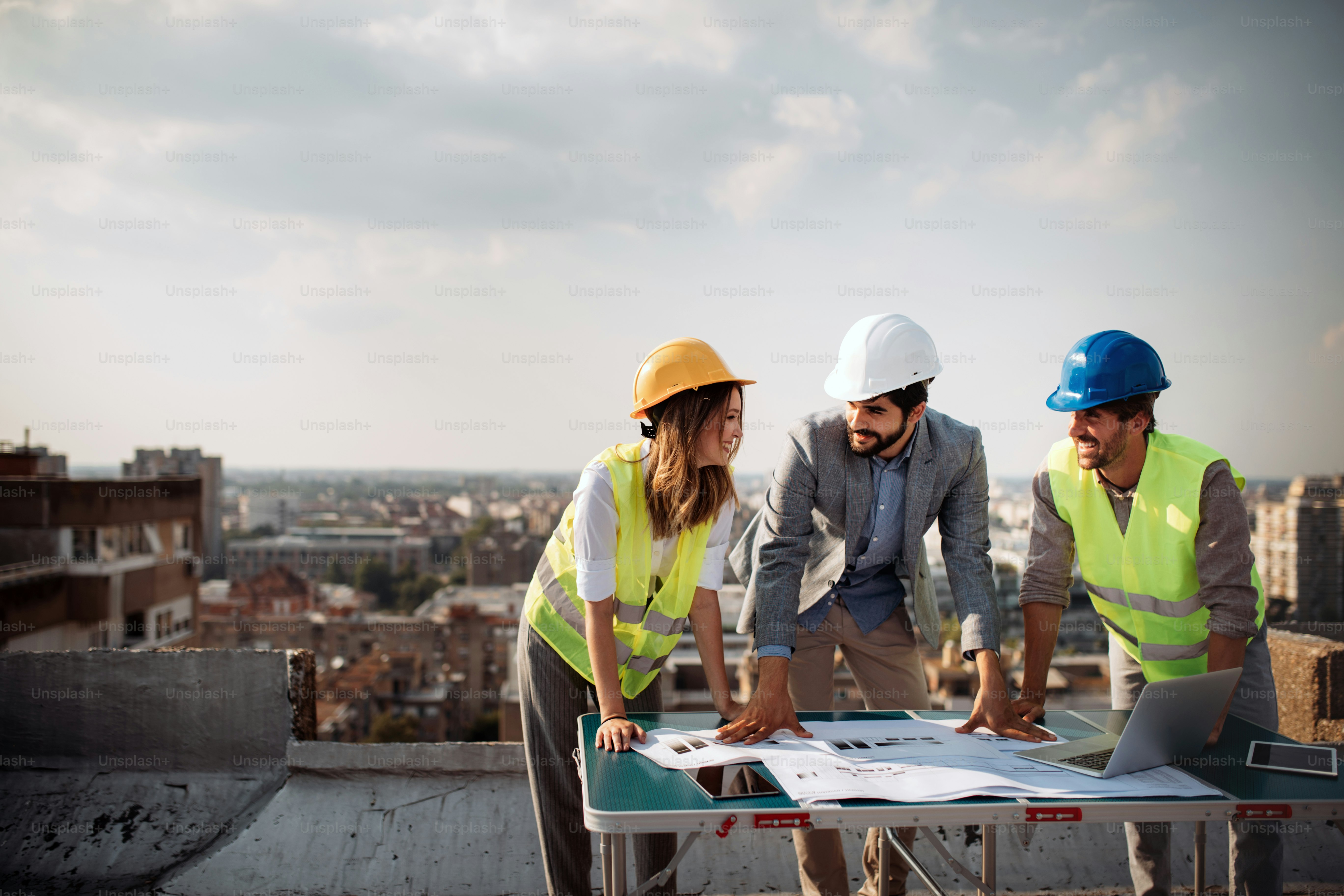 Team of architects and engineer in group on construciton site check ...