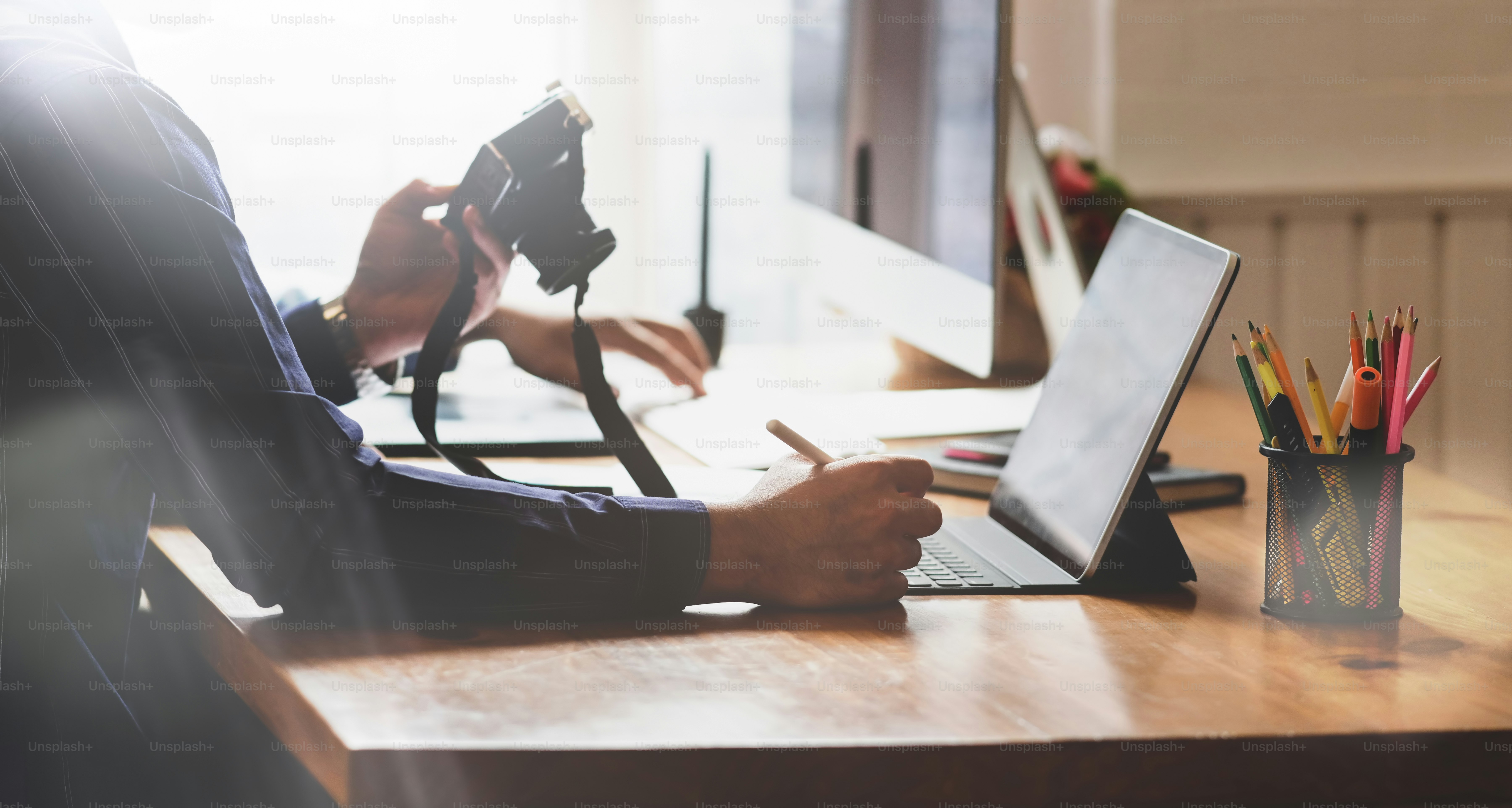 Young photographers working on their projects with tablet in modern ...