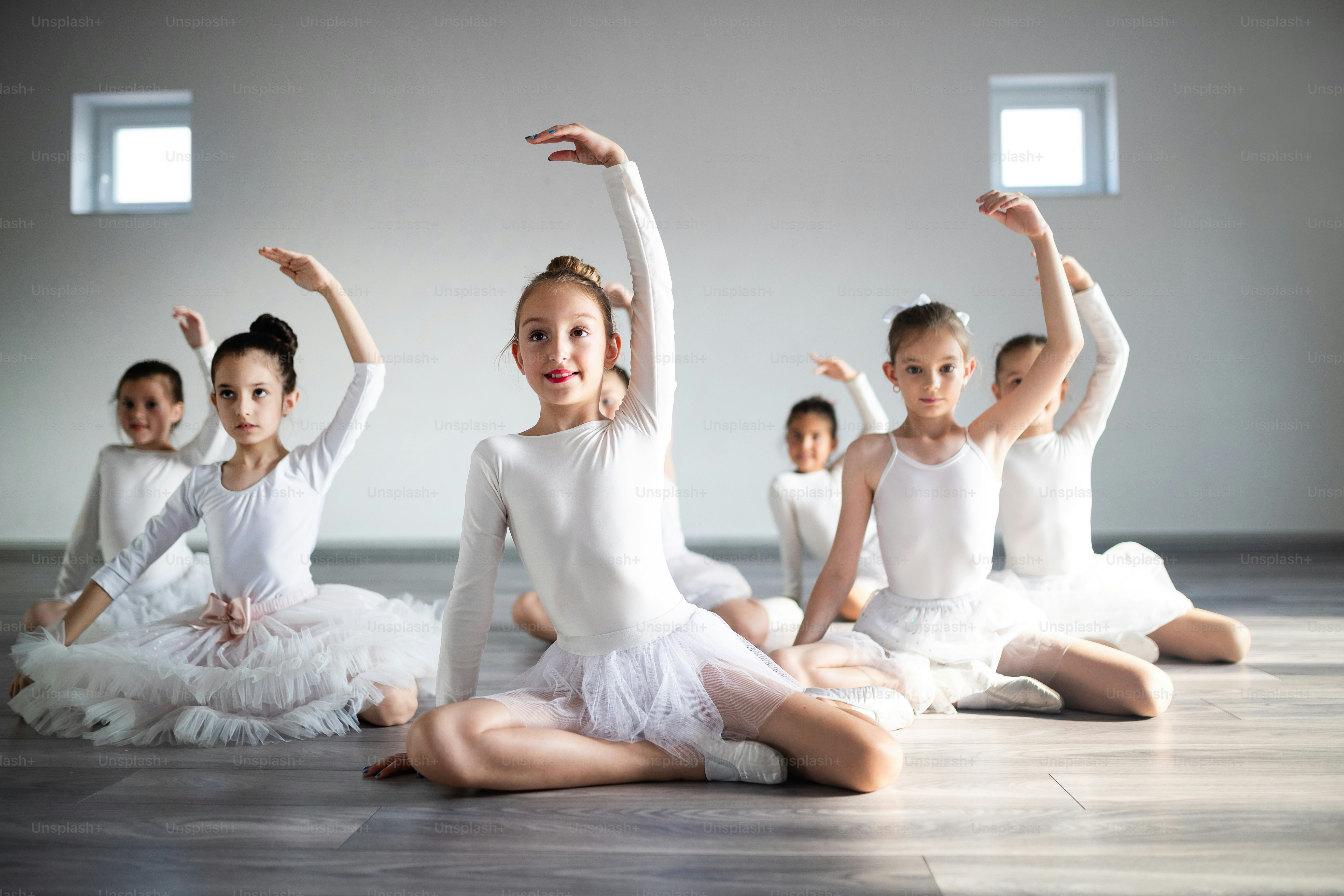 Little ballerinas in ballet studio. Group of girls exercising together ...