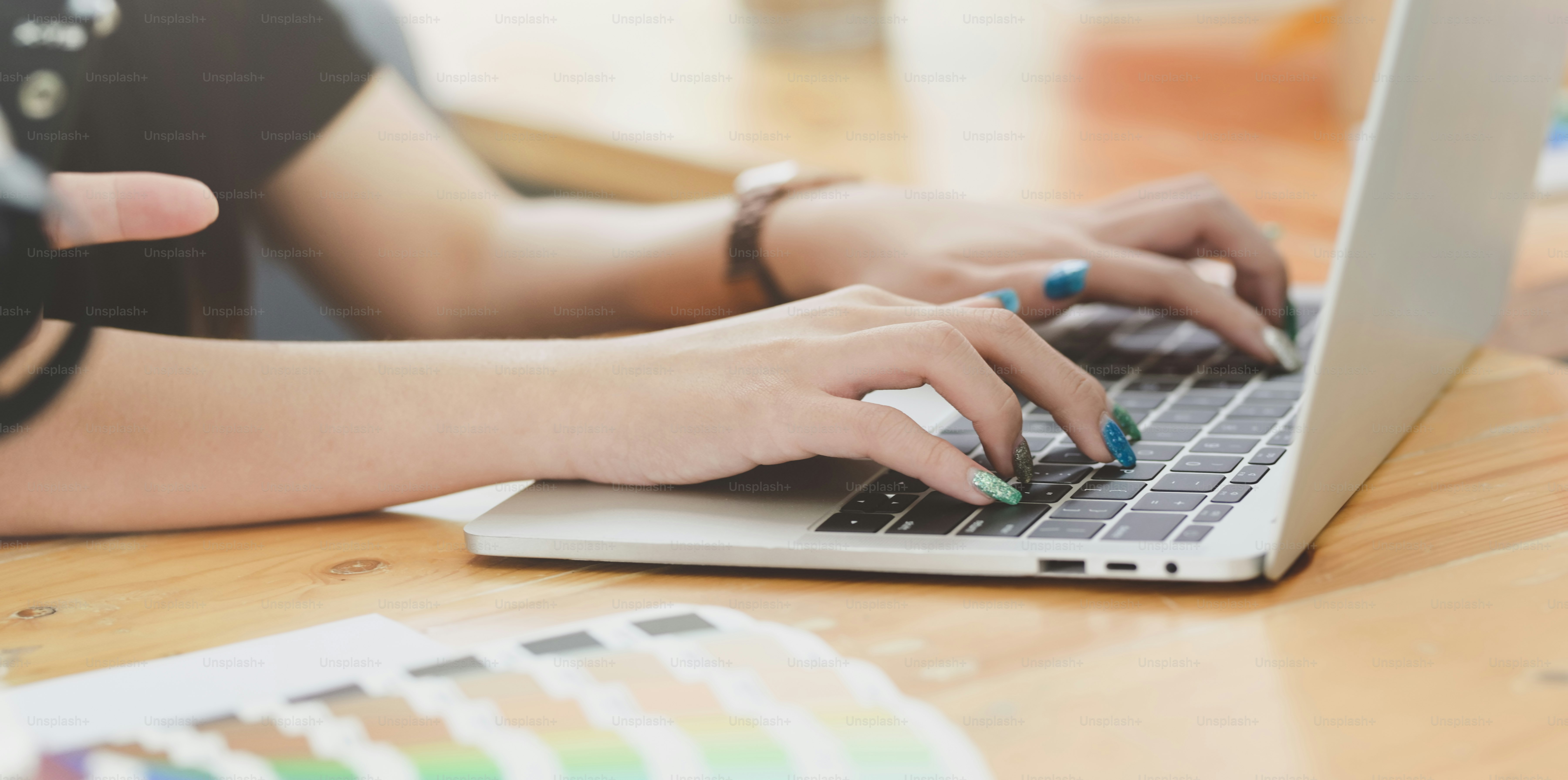 Close-up view of young motivated graphic designer typing on laptop ...