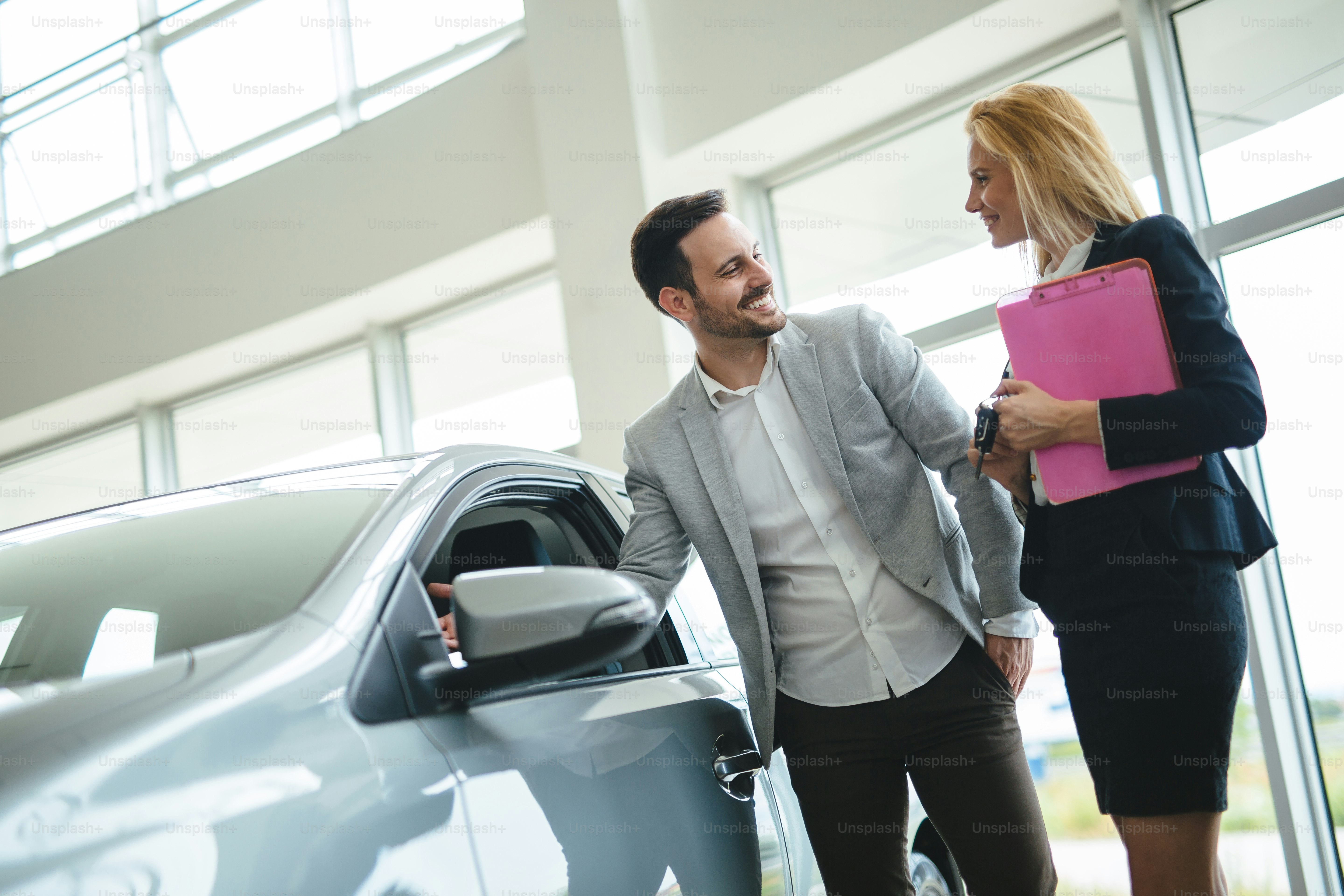Portrait of happy young customer buying new car photo – Mode of ...