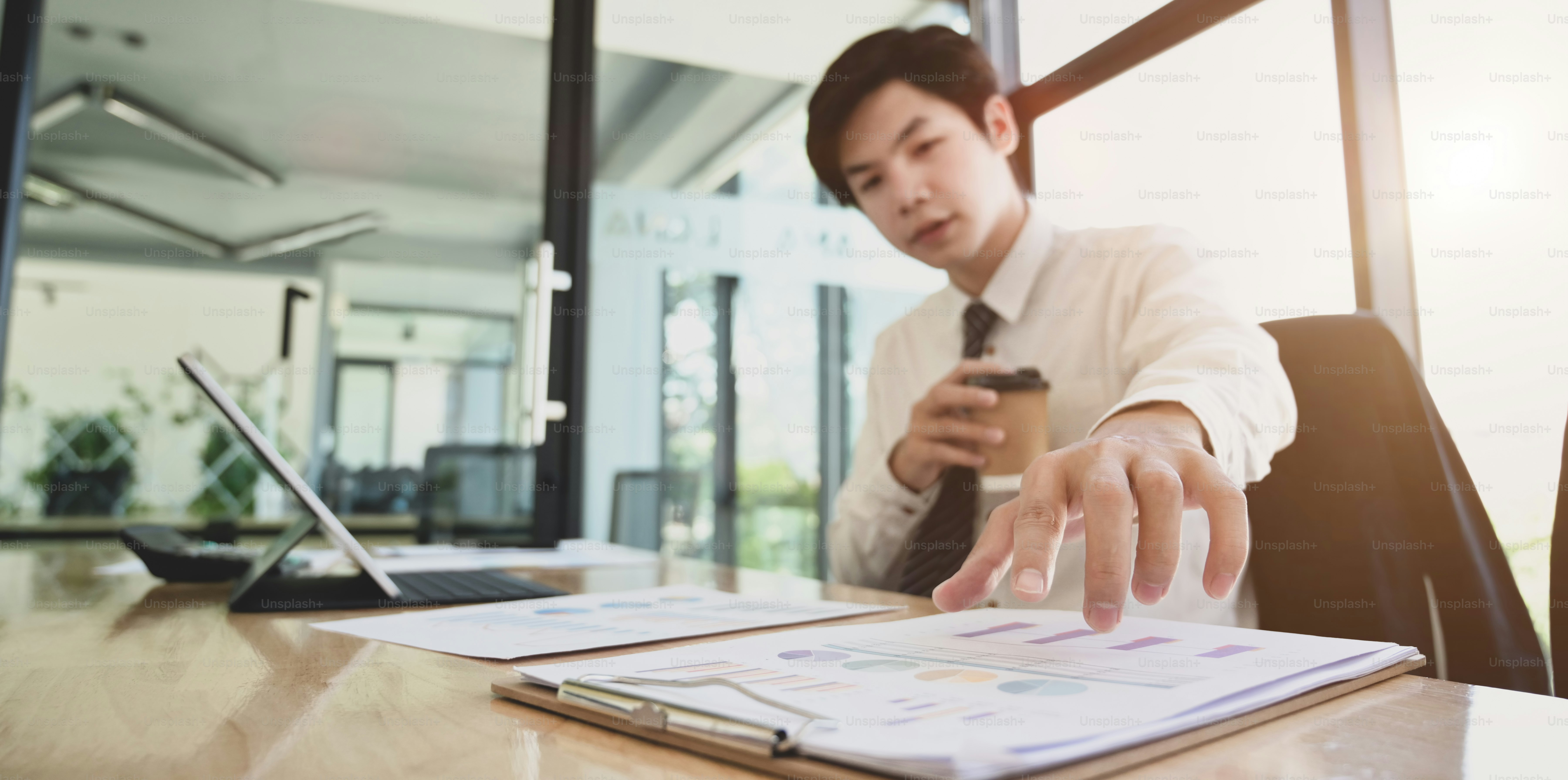 Professional male accountant compiling and analysing financial ...