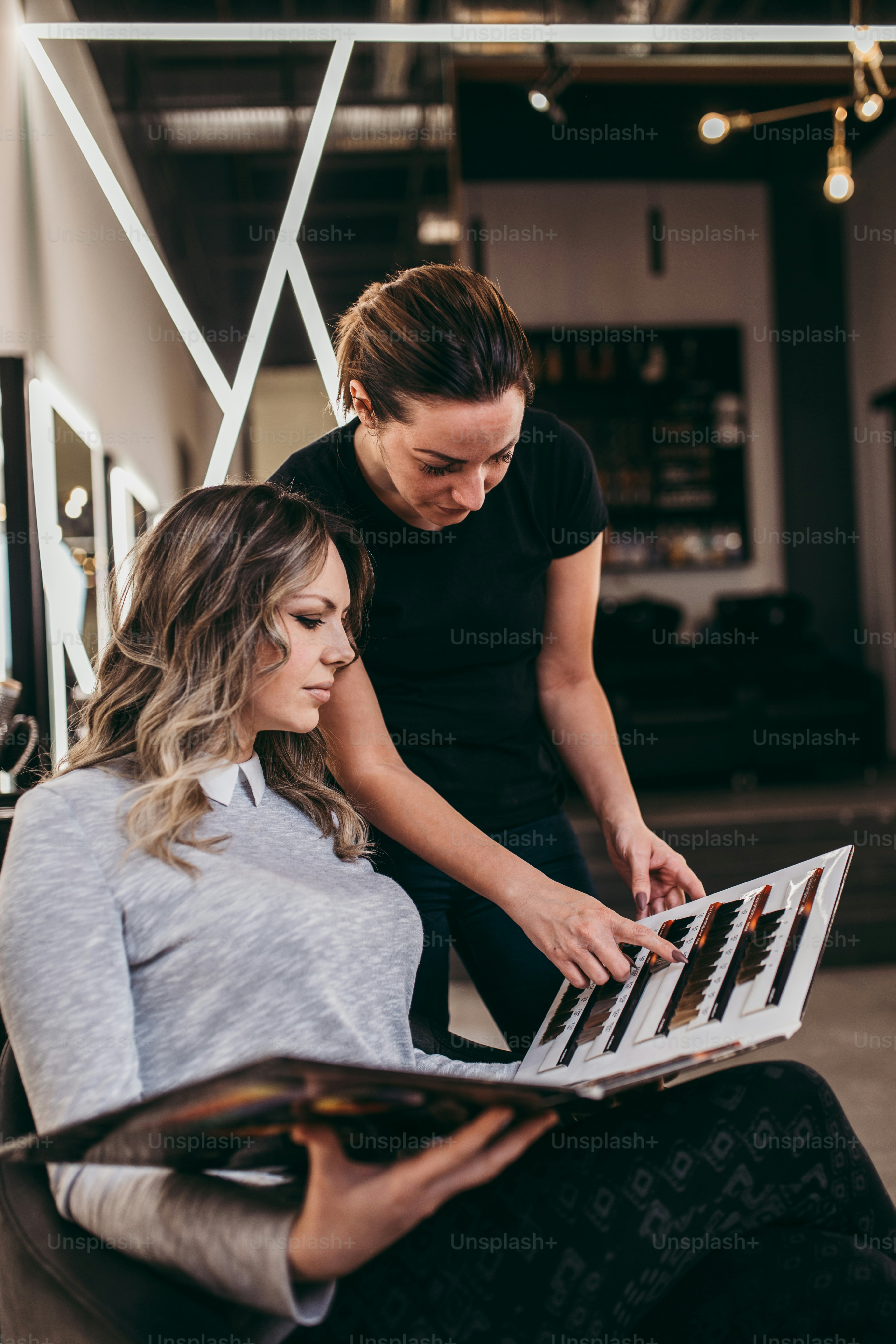 Beautiful brunette woman with long hair at the beauty salon getting a ...