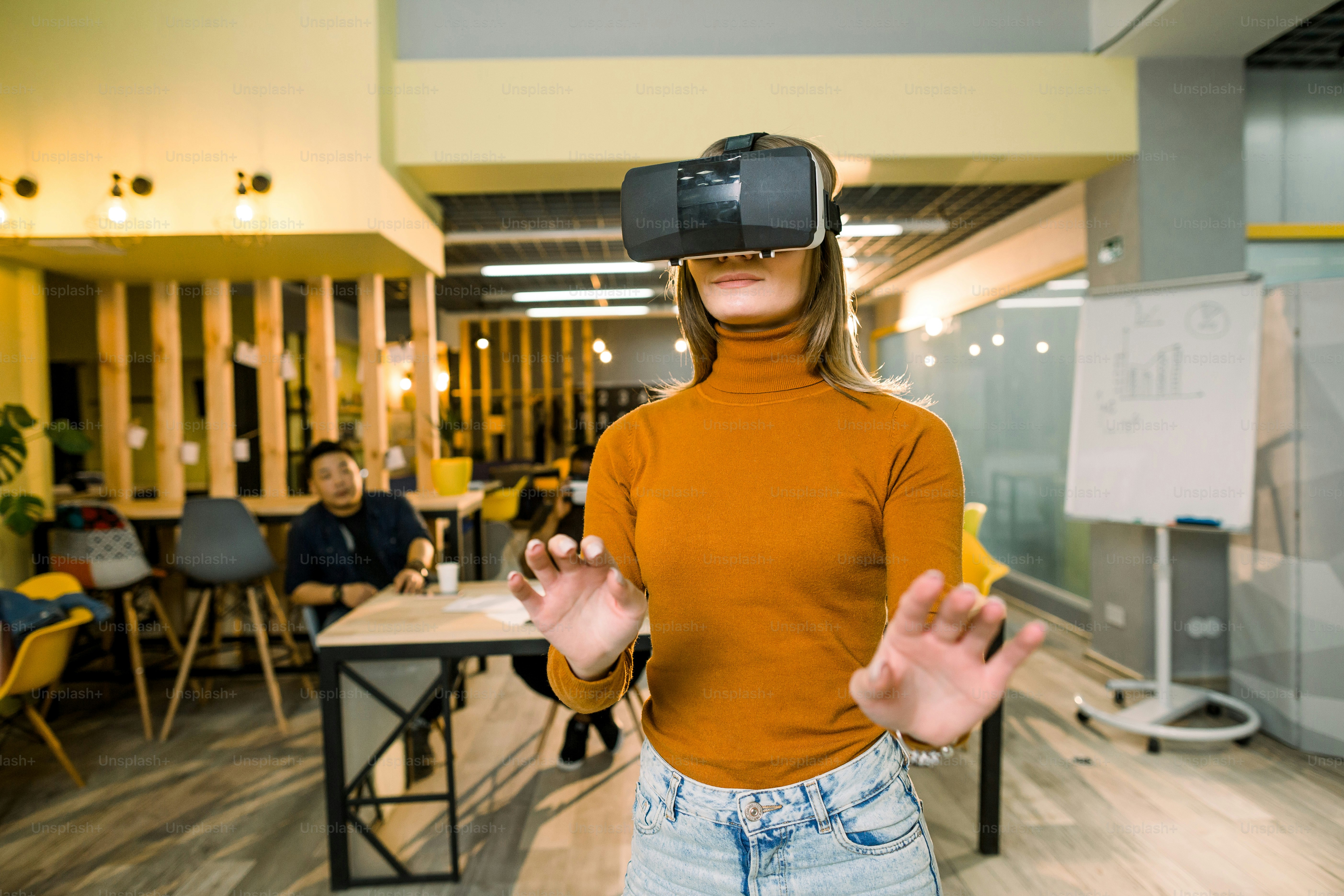 Cheerful young woman adjusting her virtual reality headset and excited ...