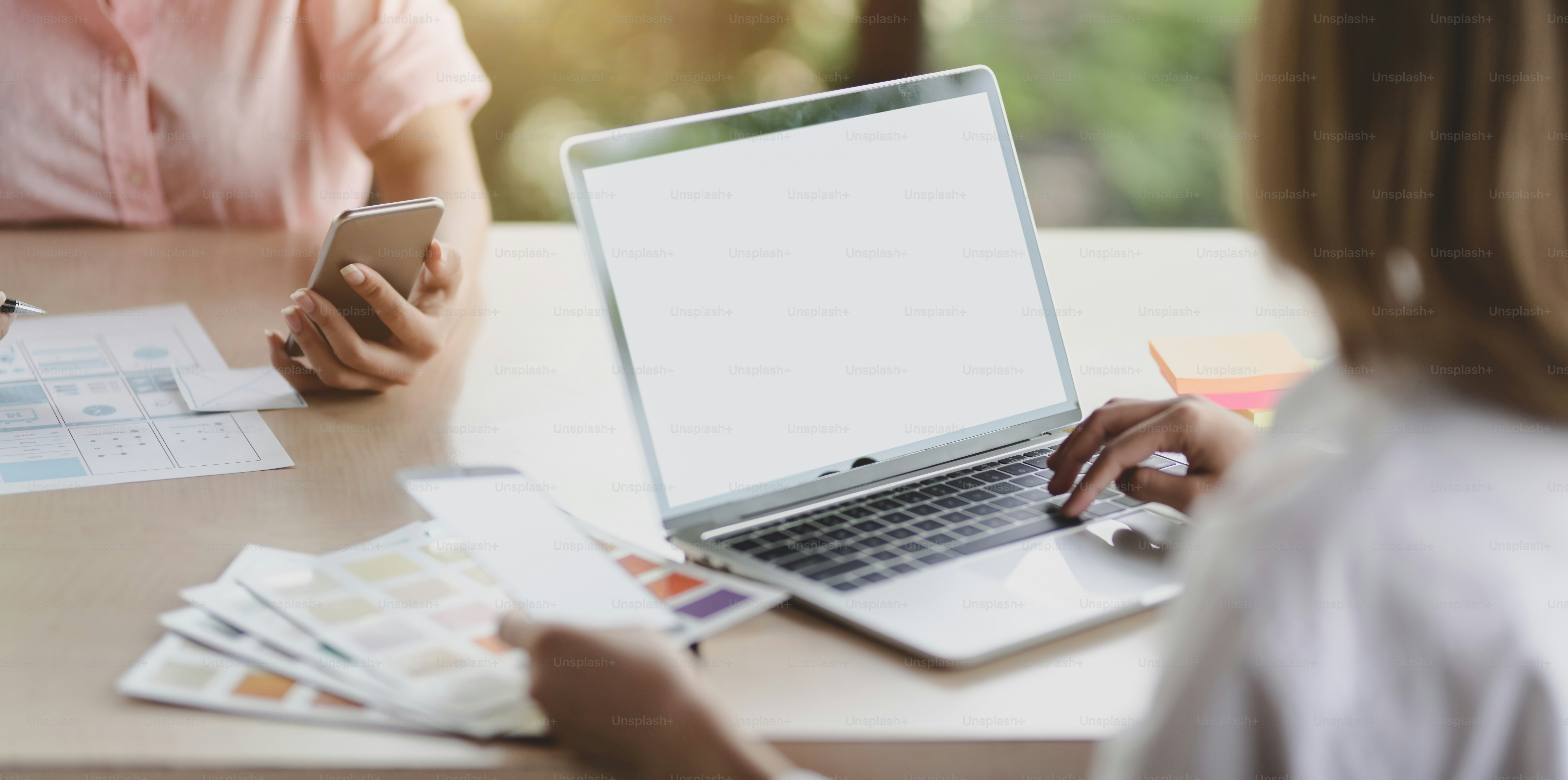 Close-up view of young professional ui web developer working on her ...