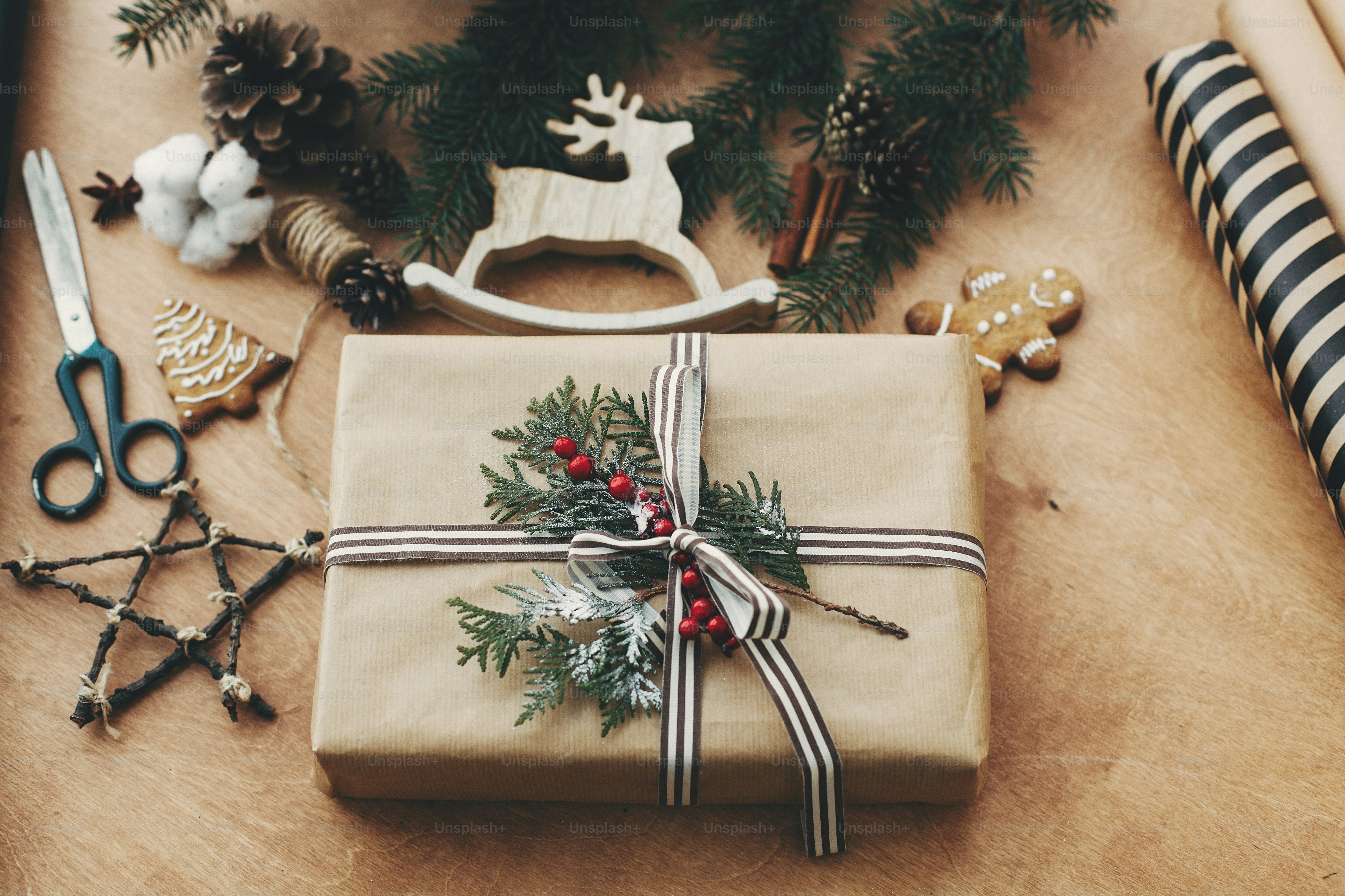 Stylish rustic christmas gift box, wrapping paper, wooden reindeer ...