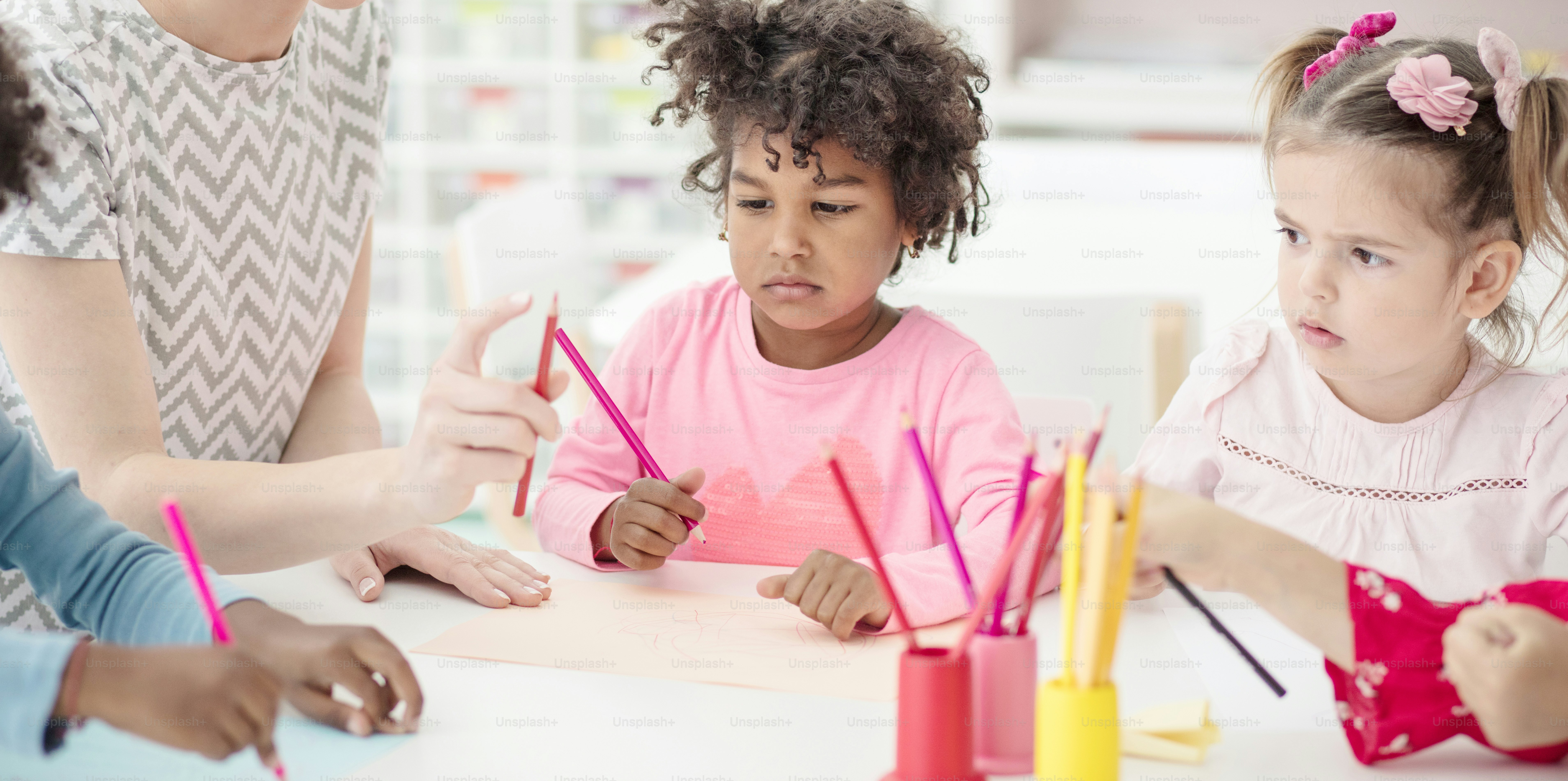 This is a red color. Children in preschool with teacher. photo ...