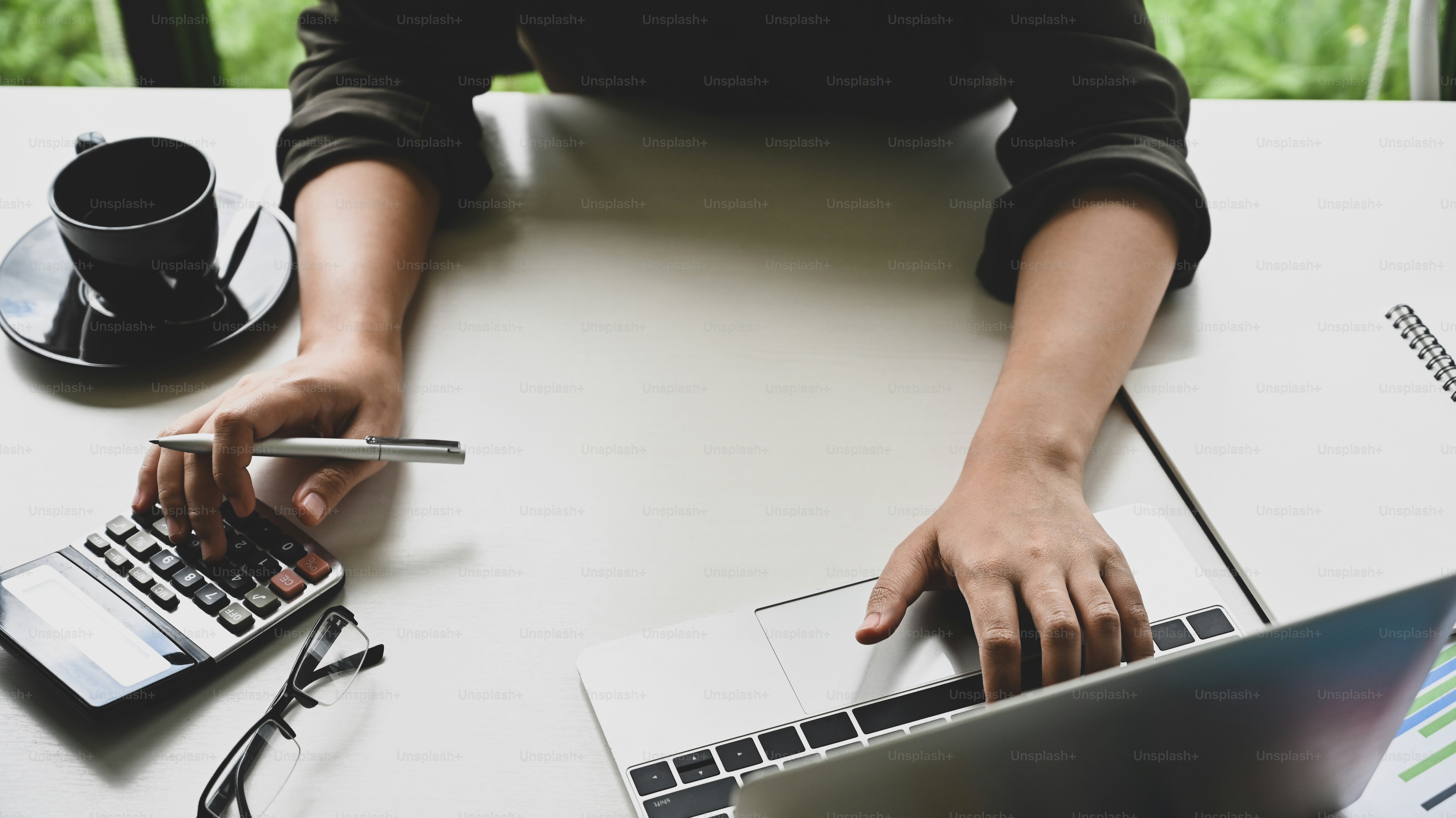 Closeup finance concept, female using calculator and laptop computer on ...