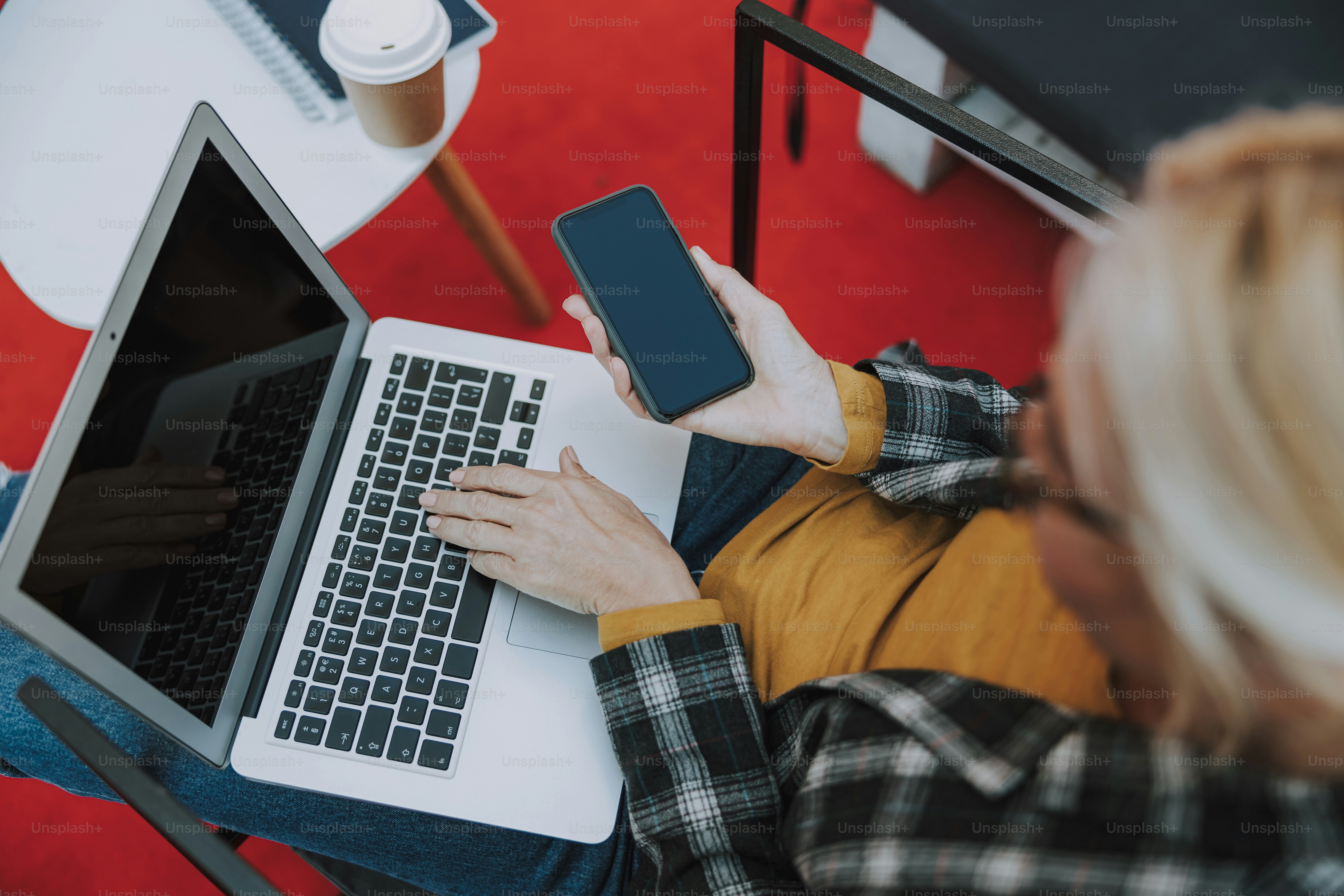 Top view of a business lady using her laptop and smartphone in an ...