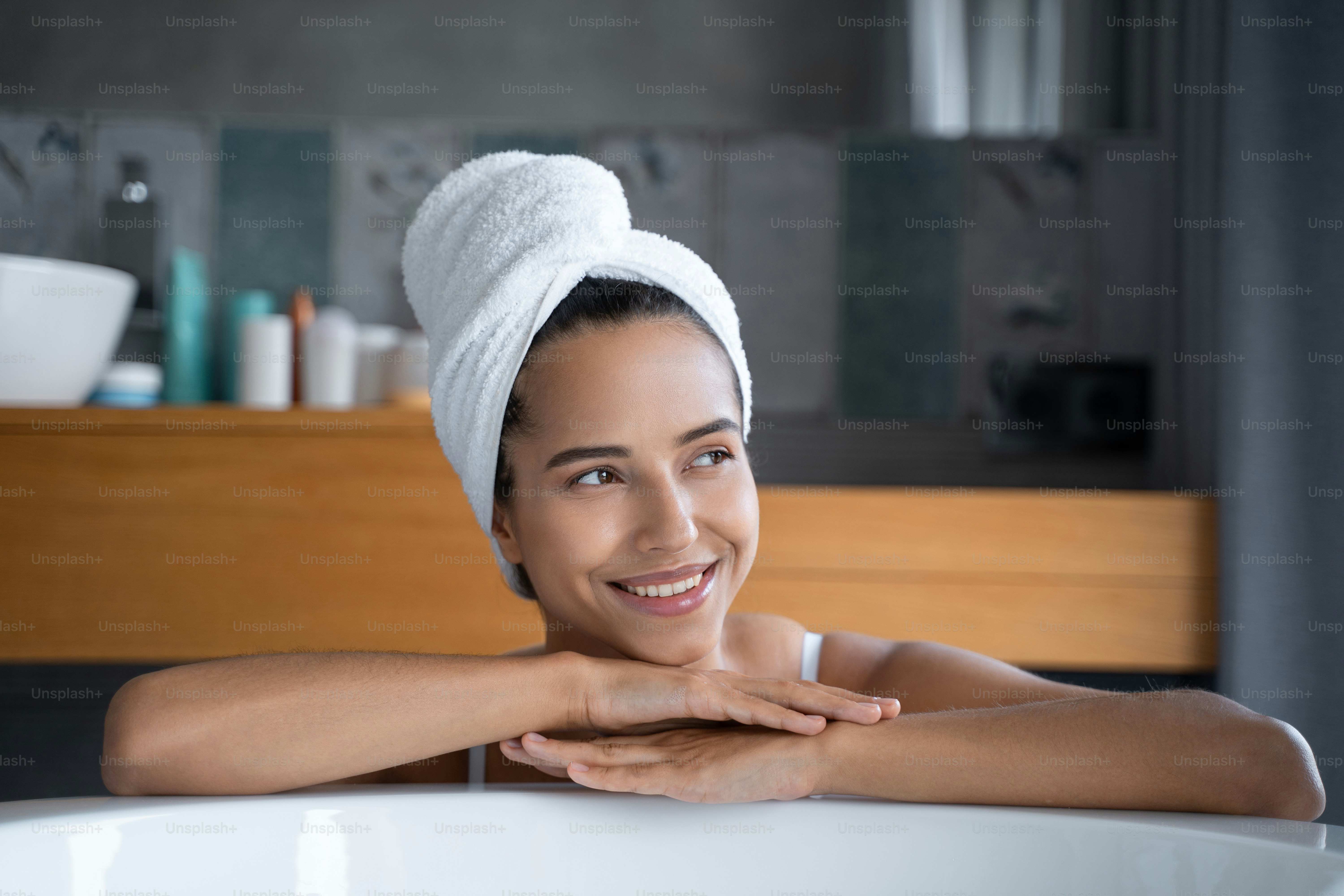 Closeup portrait of a smiling beautiful young lady leaning on the edge ...